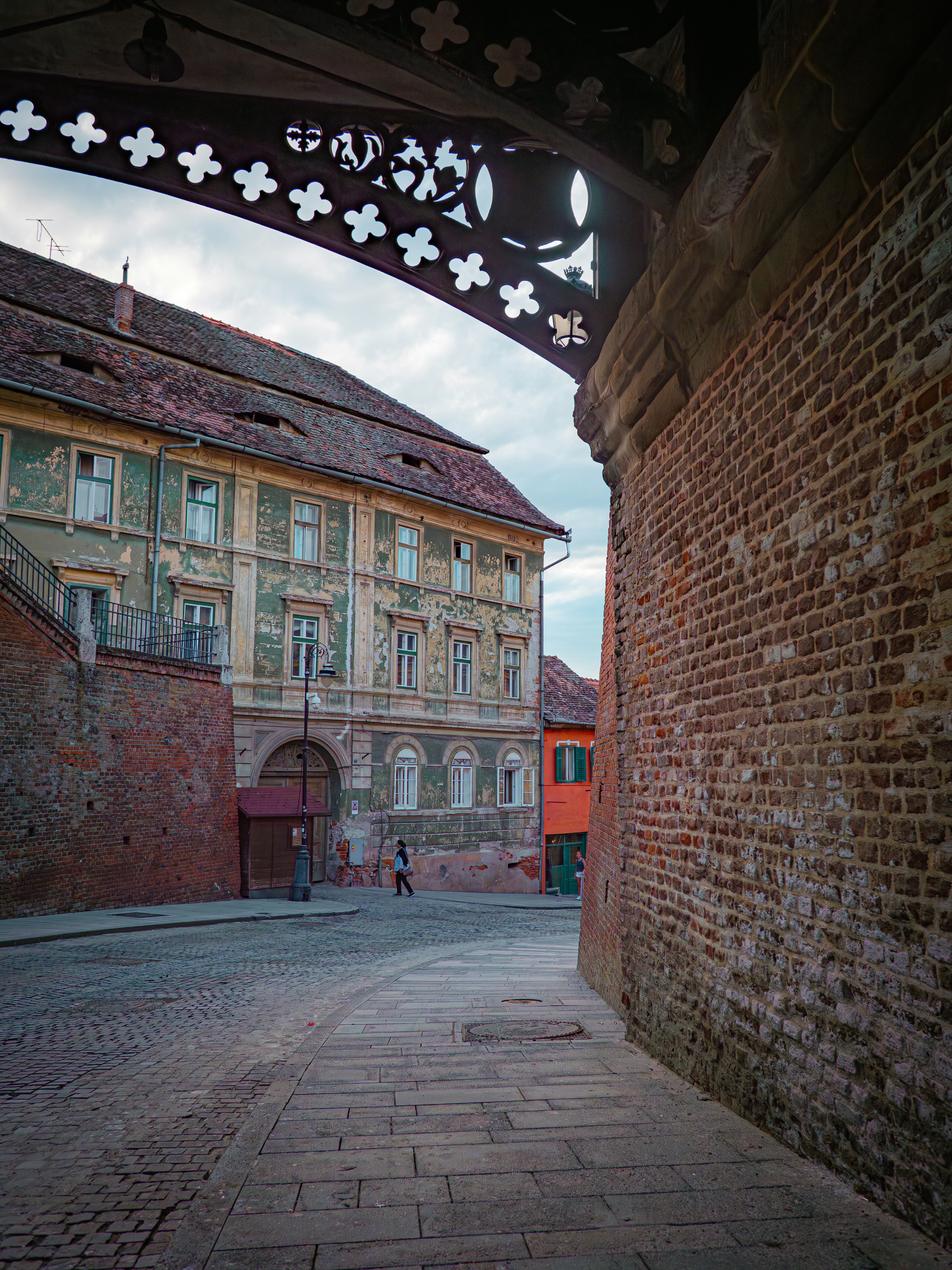 Old brick building with arched entrance and checkered entryway