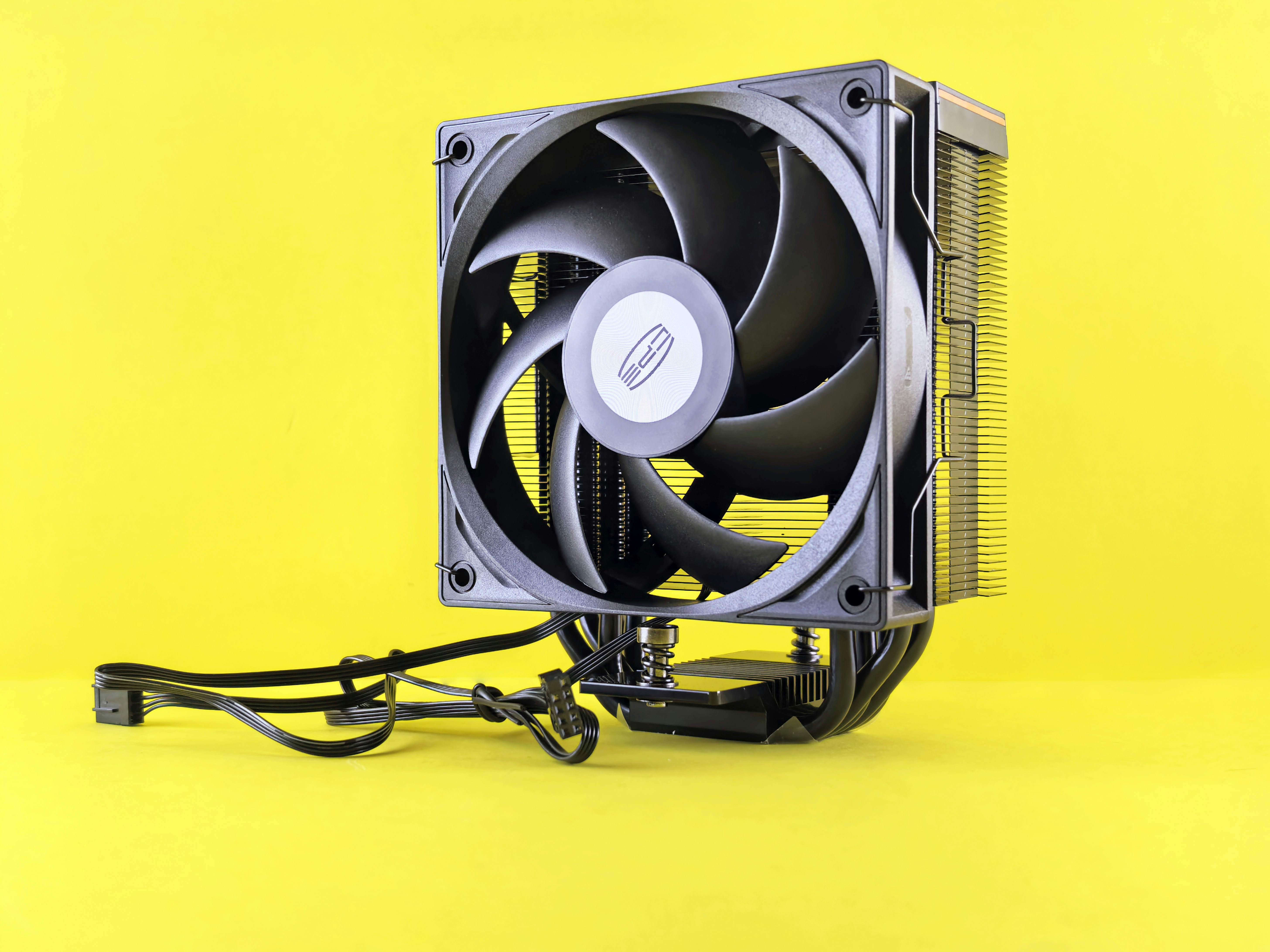 Computer cpu cooler with fan on yellow background