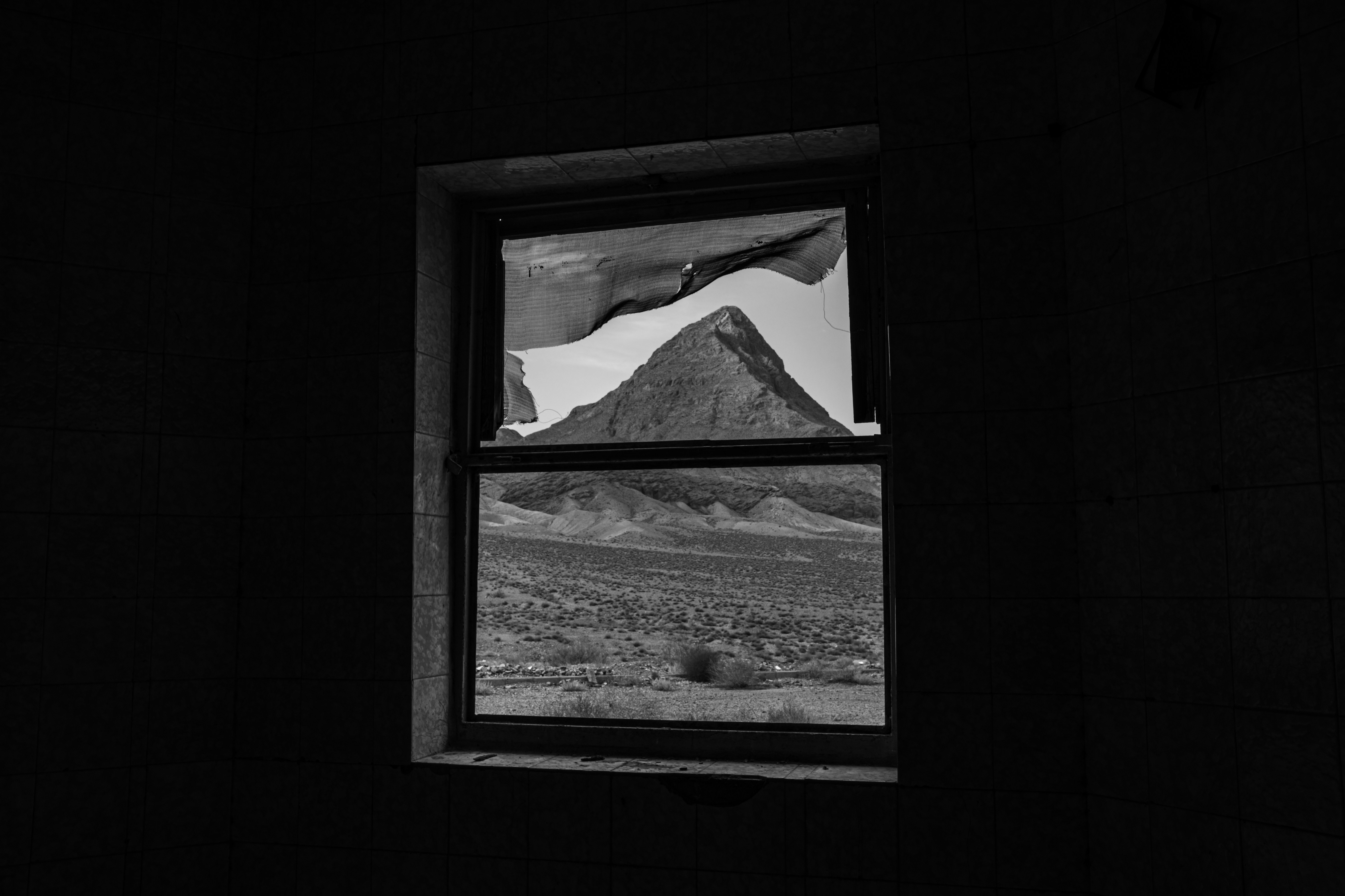 Mountain view through a broken window