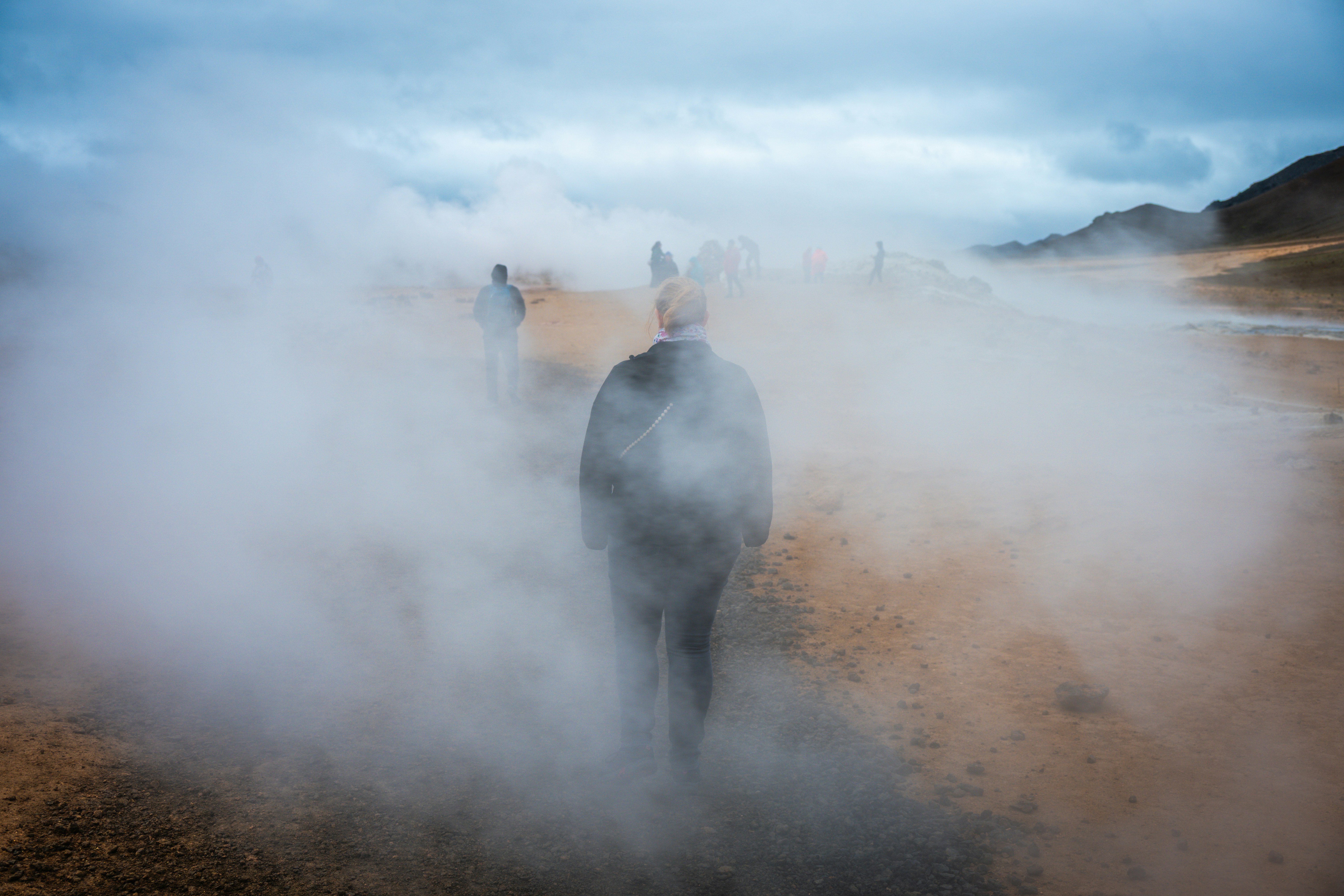 Geothermal Ghosts: A Lone Traveler Threads Through a Field of Steam