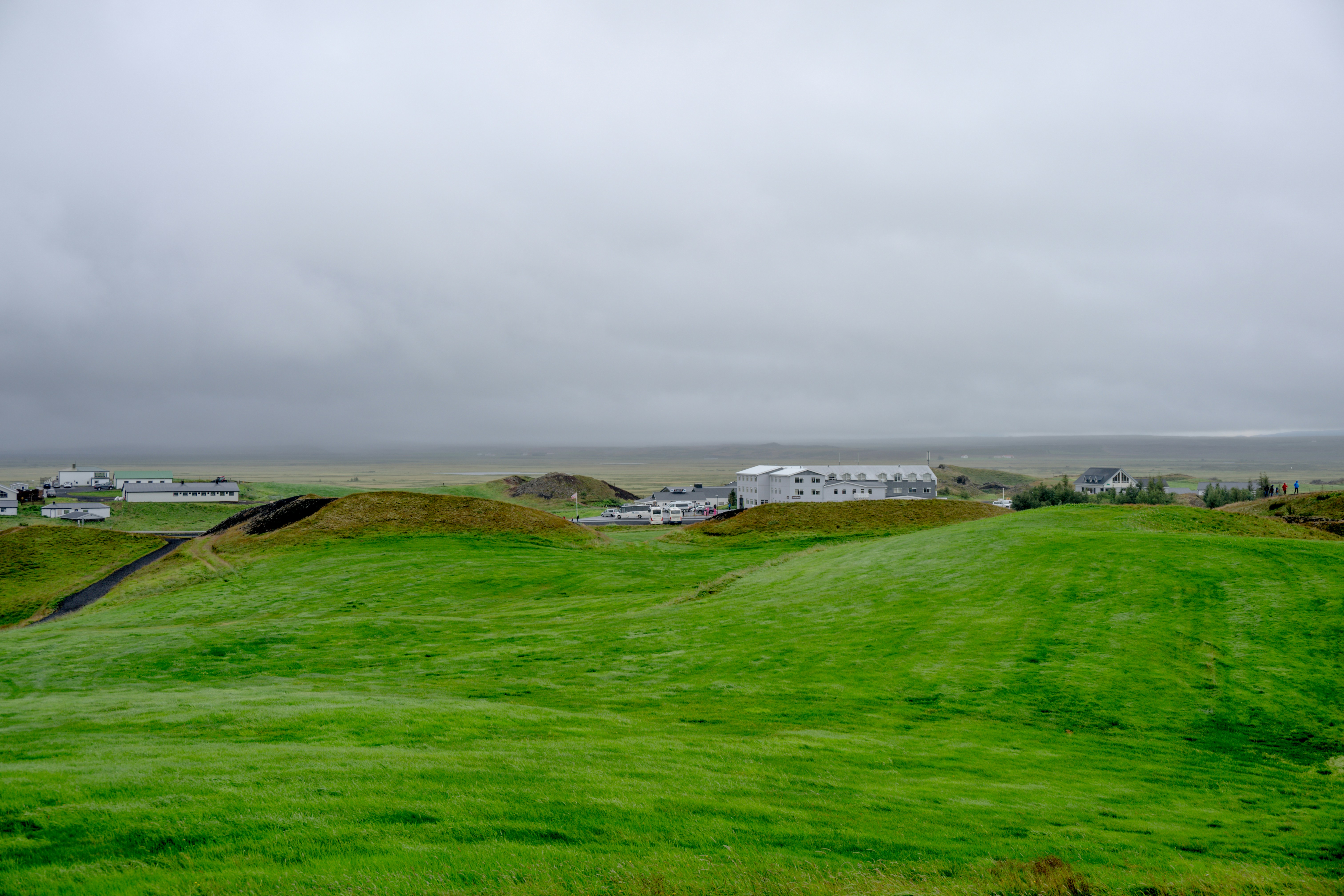Green rolling hills under a cloudy sky
