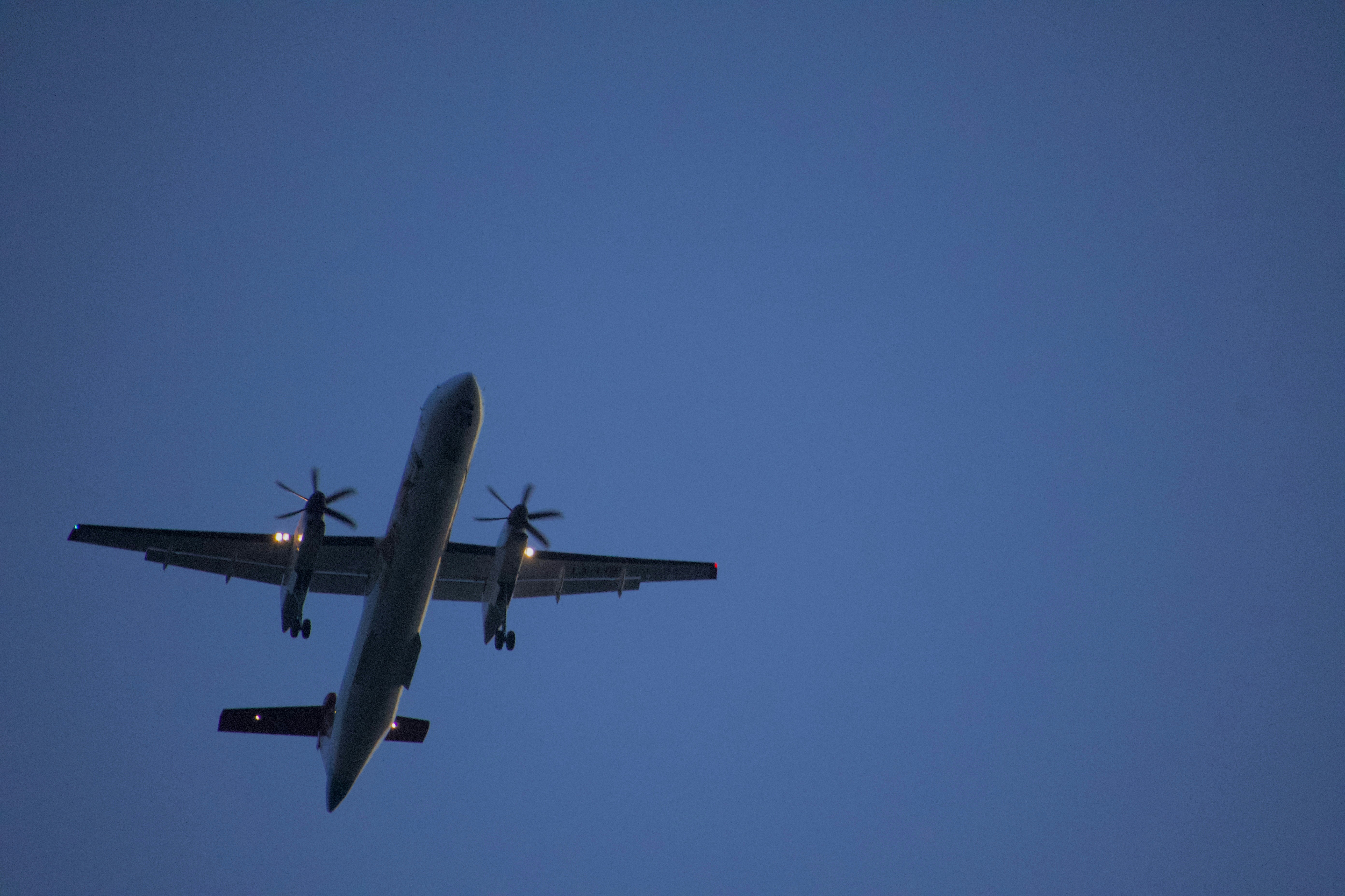 Turboprop airplane flying high in a clear blue sky