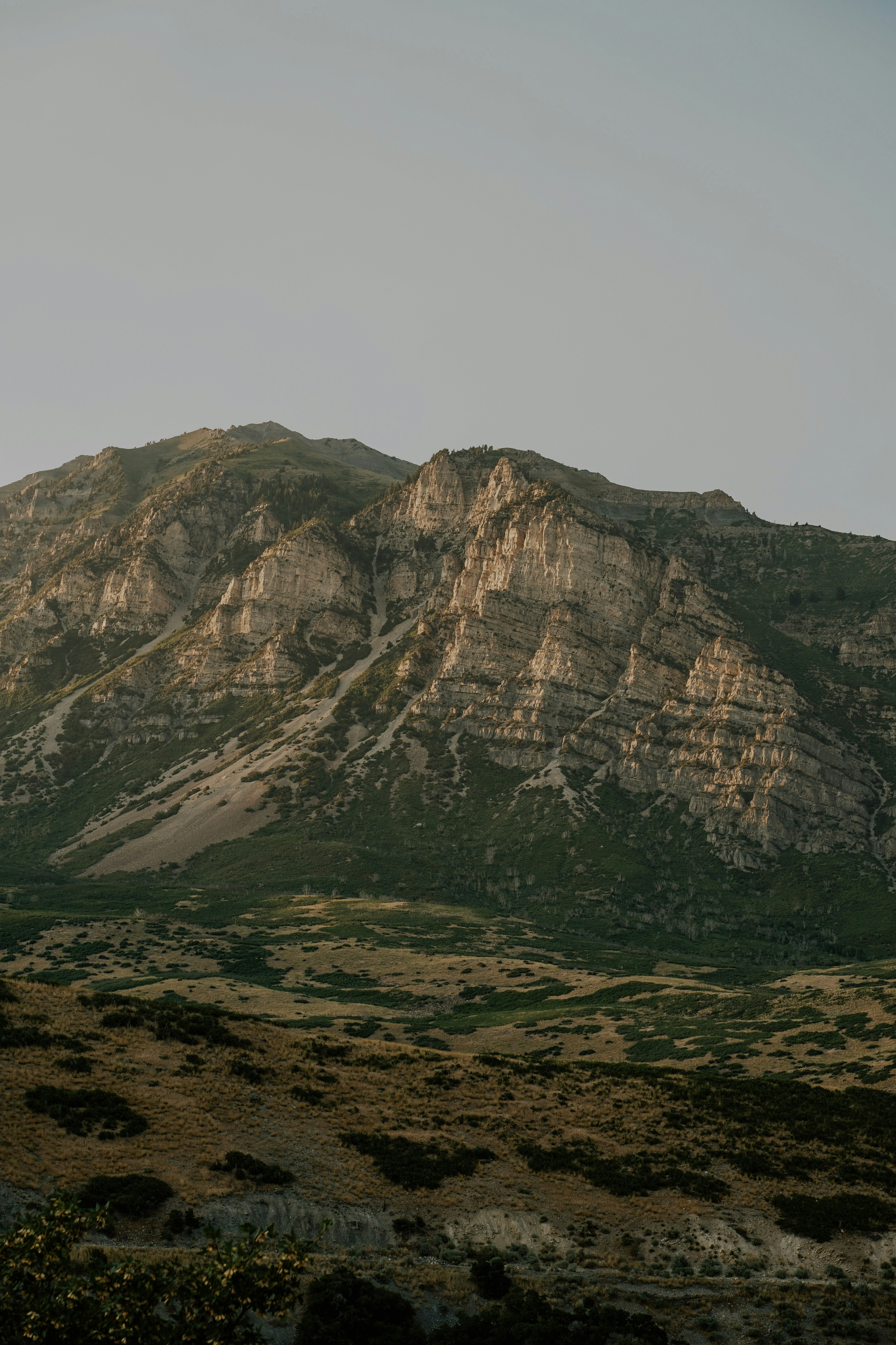 Sunlit mountain range under a clear sky