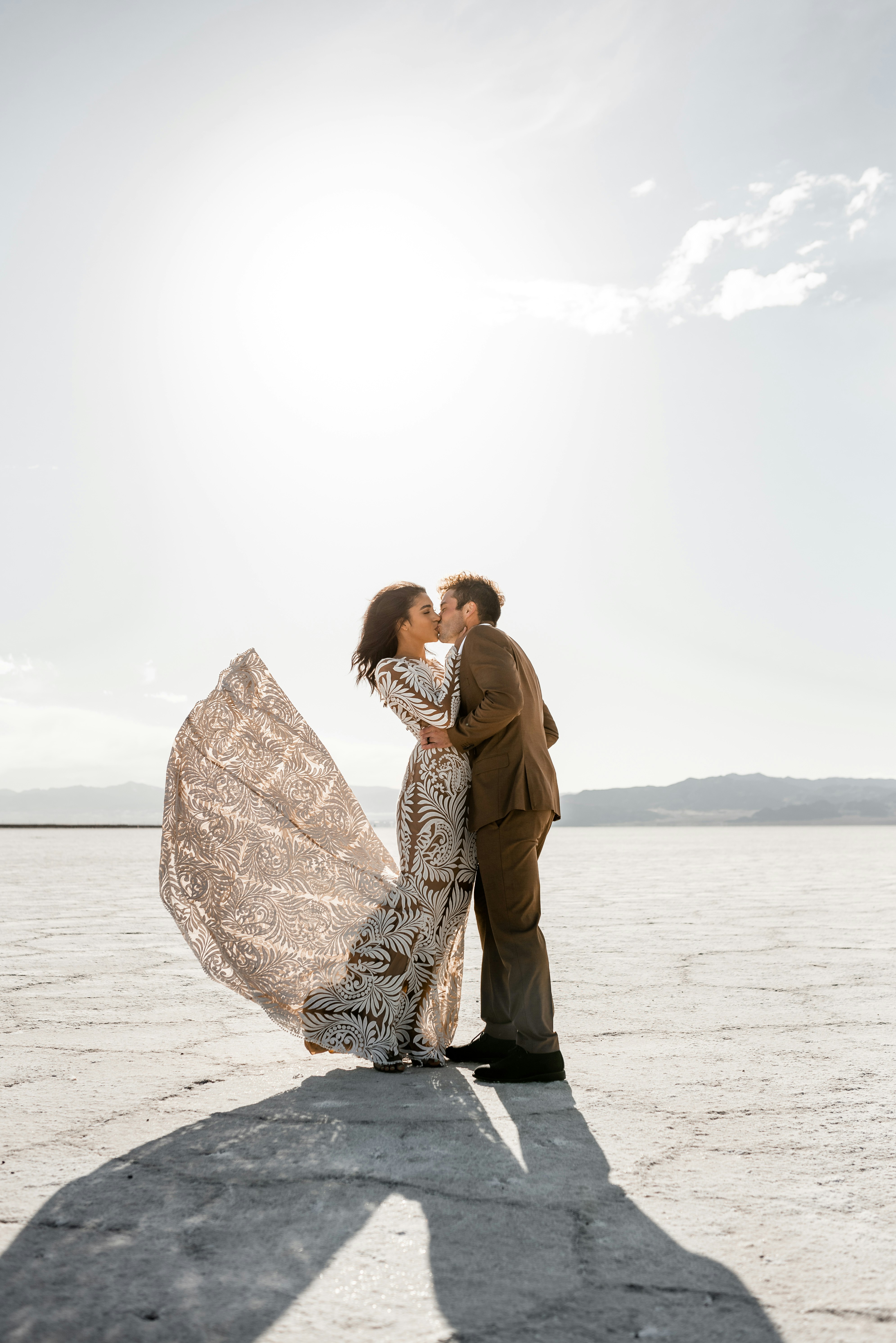 This bride's boho dress was gorgeous! | Couple kissing on a vast white landscape