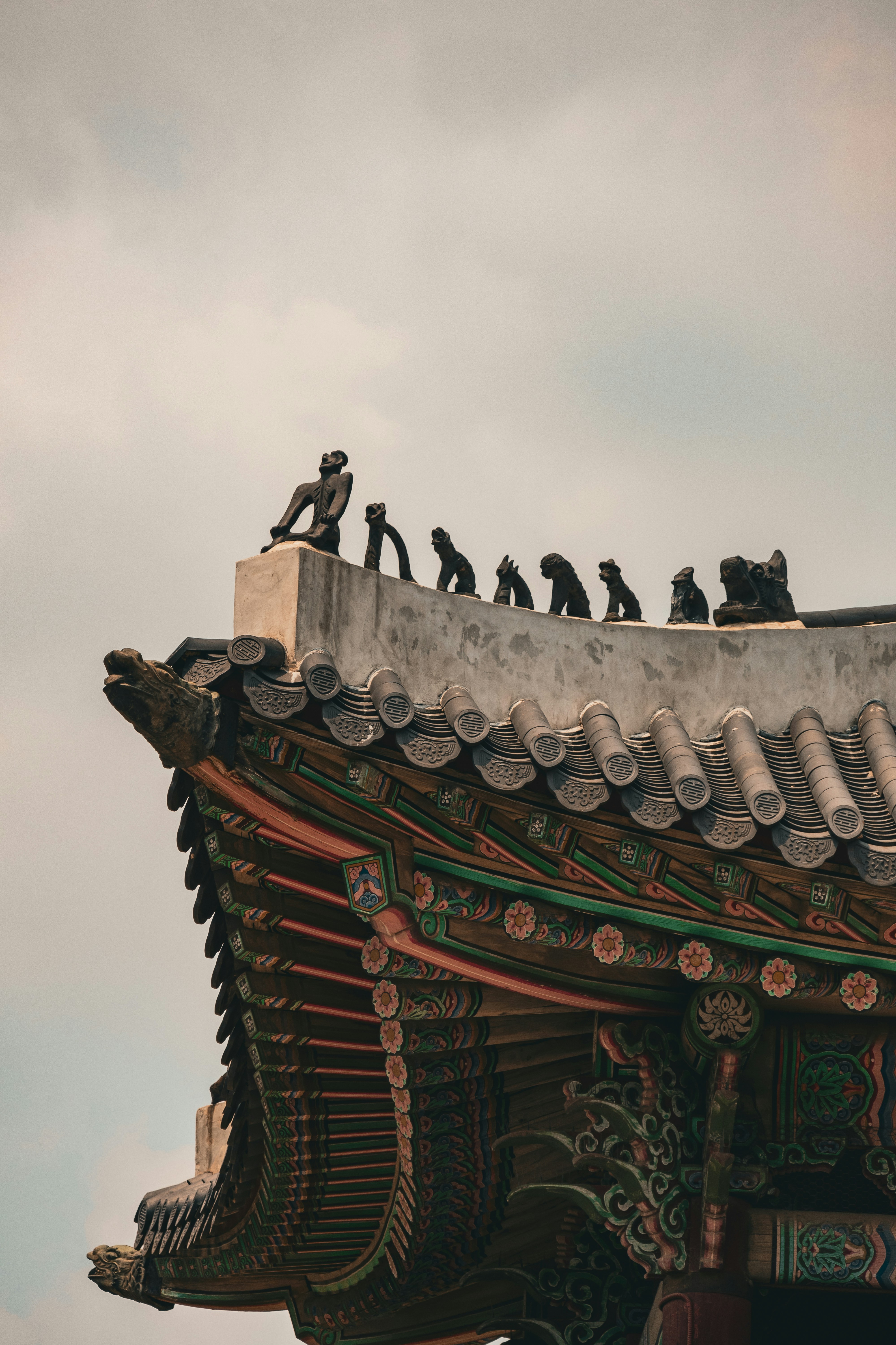 Traditional asian roof with ornate details and statues