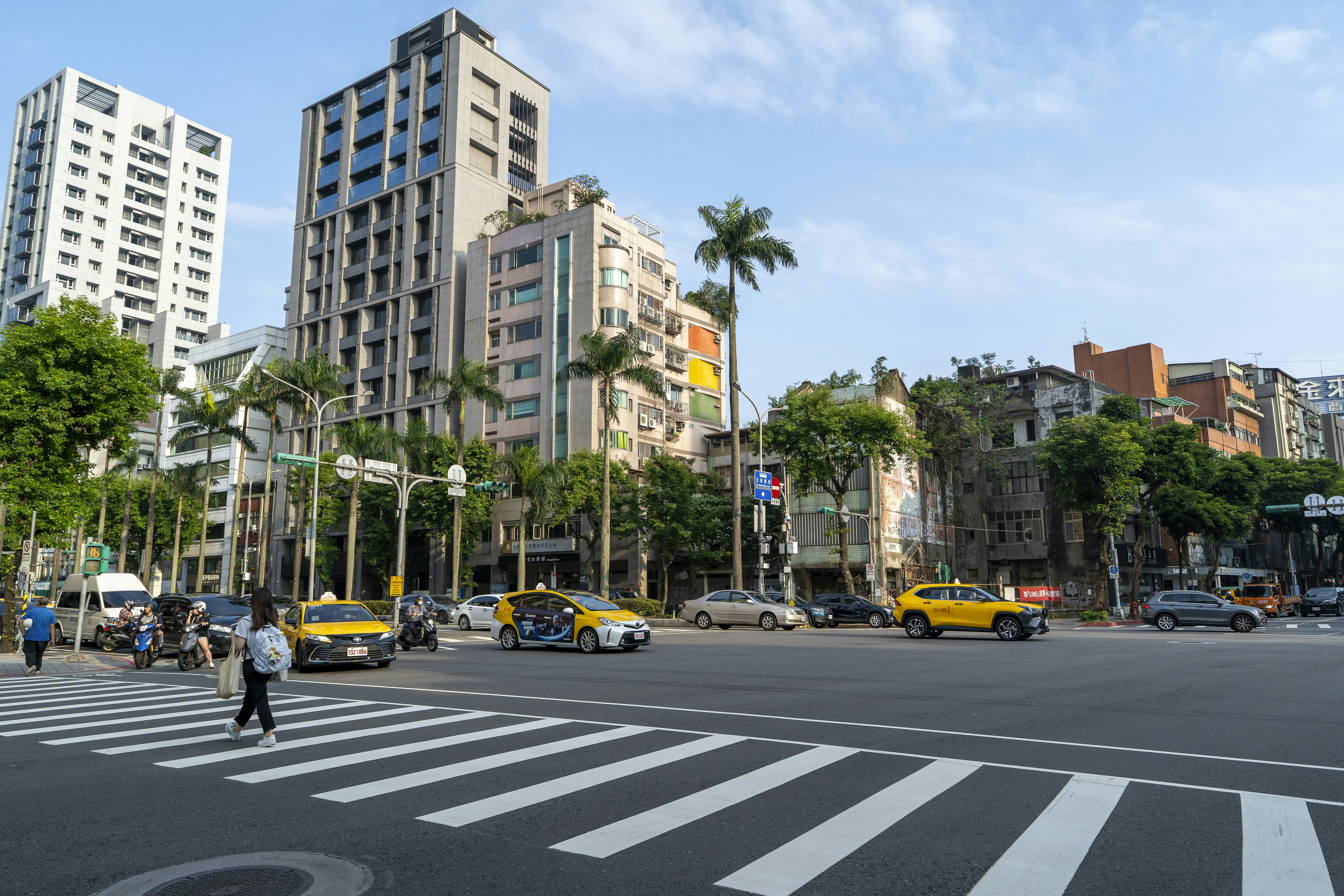 a cross section in the city of Taipei | City street with buildings and yellow taxis