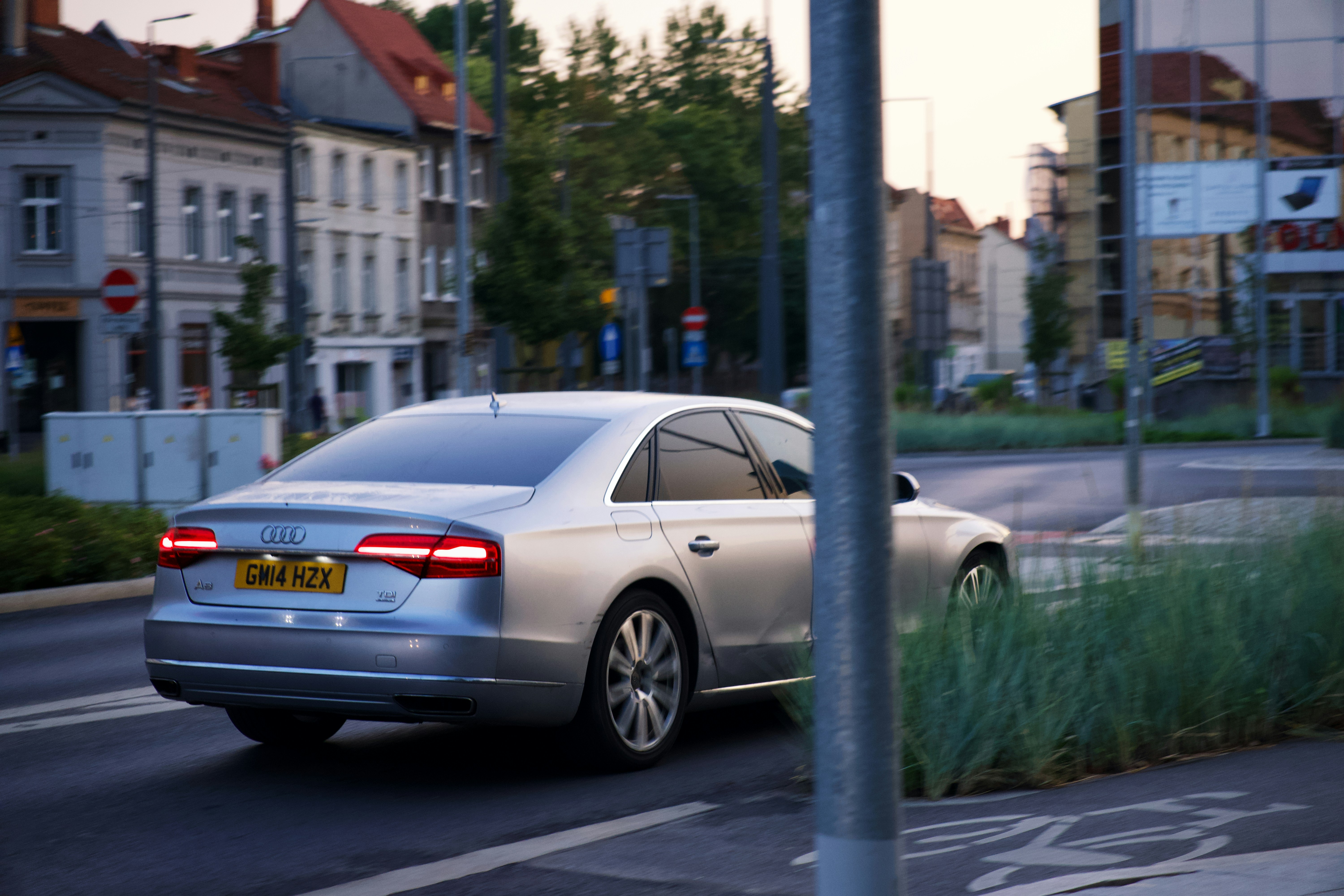 Audi | Silver car driving on a city street