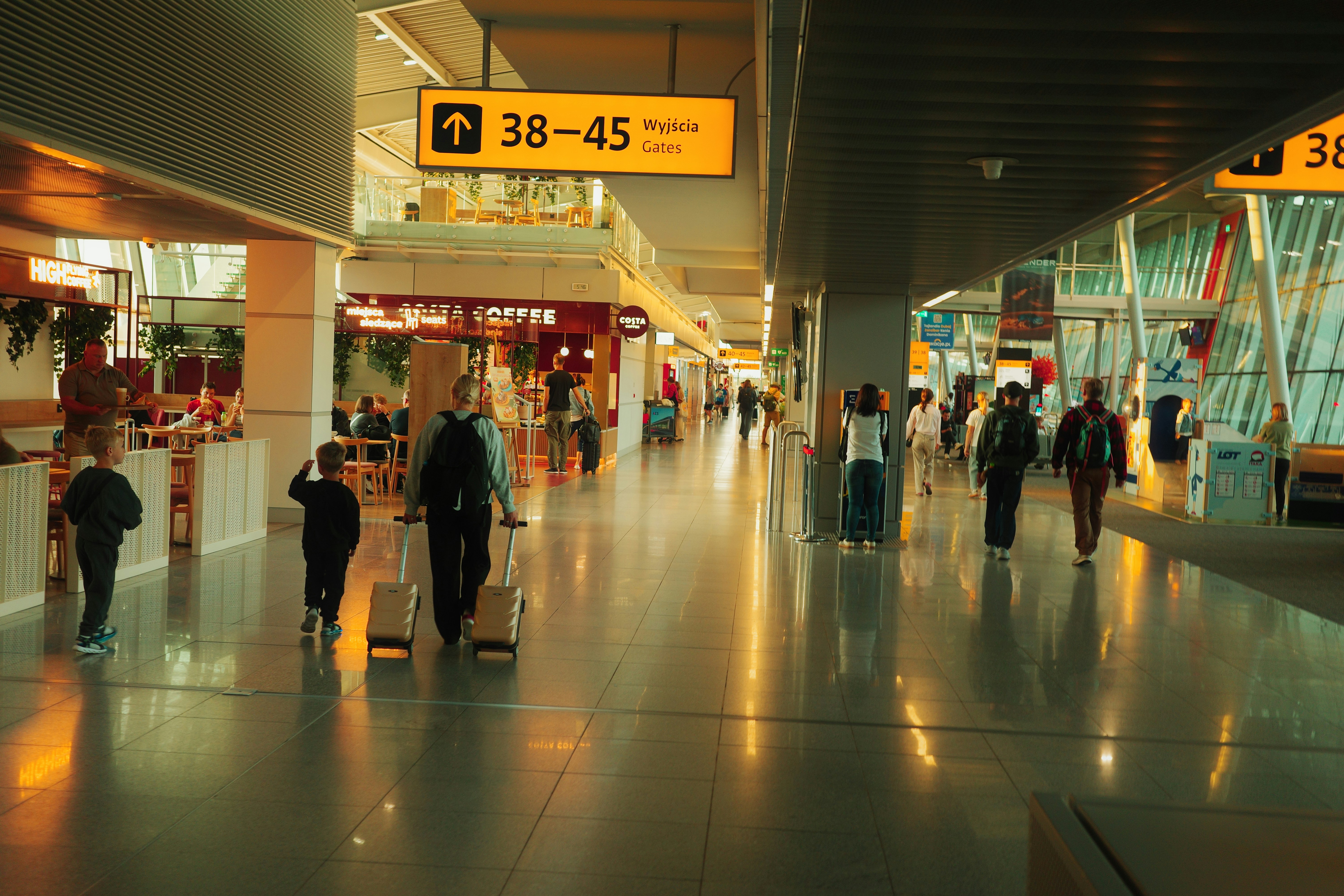 Warsaw airport | People walking through a modern airport terminal