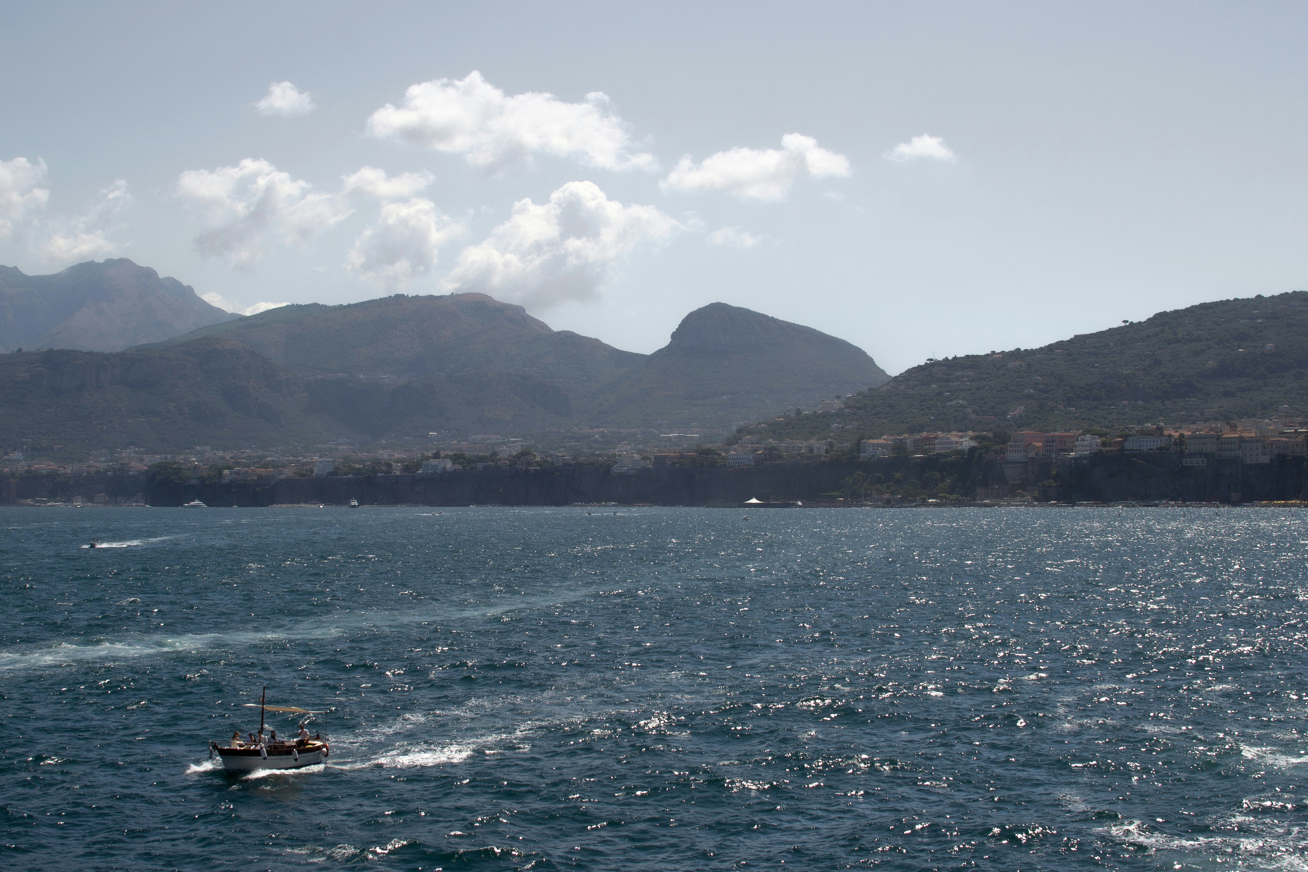 Sailboat on the water with mountains in background