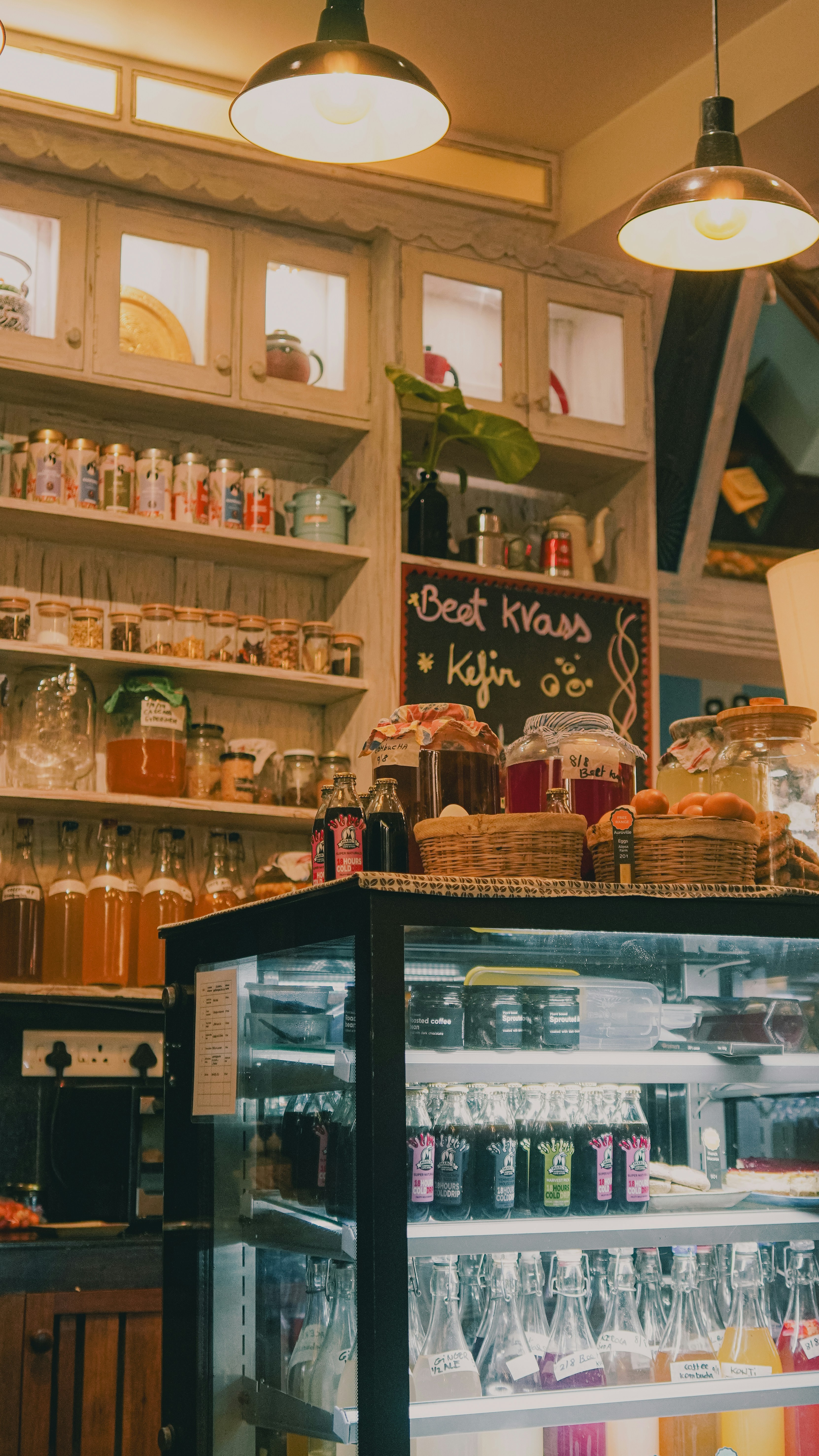 Cozy cafe interior with display shelves and counter.
