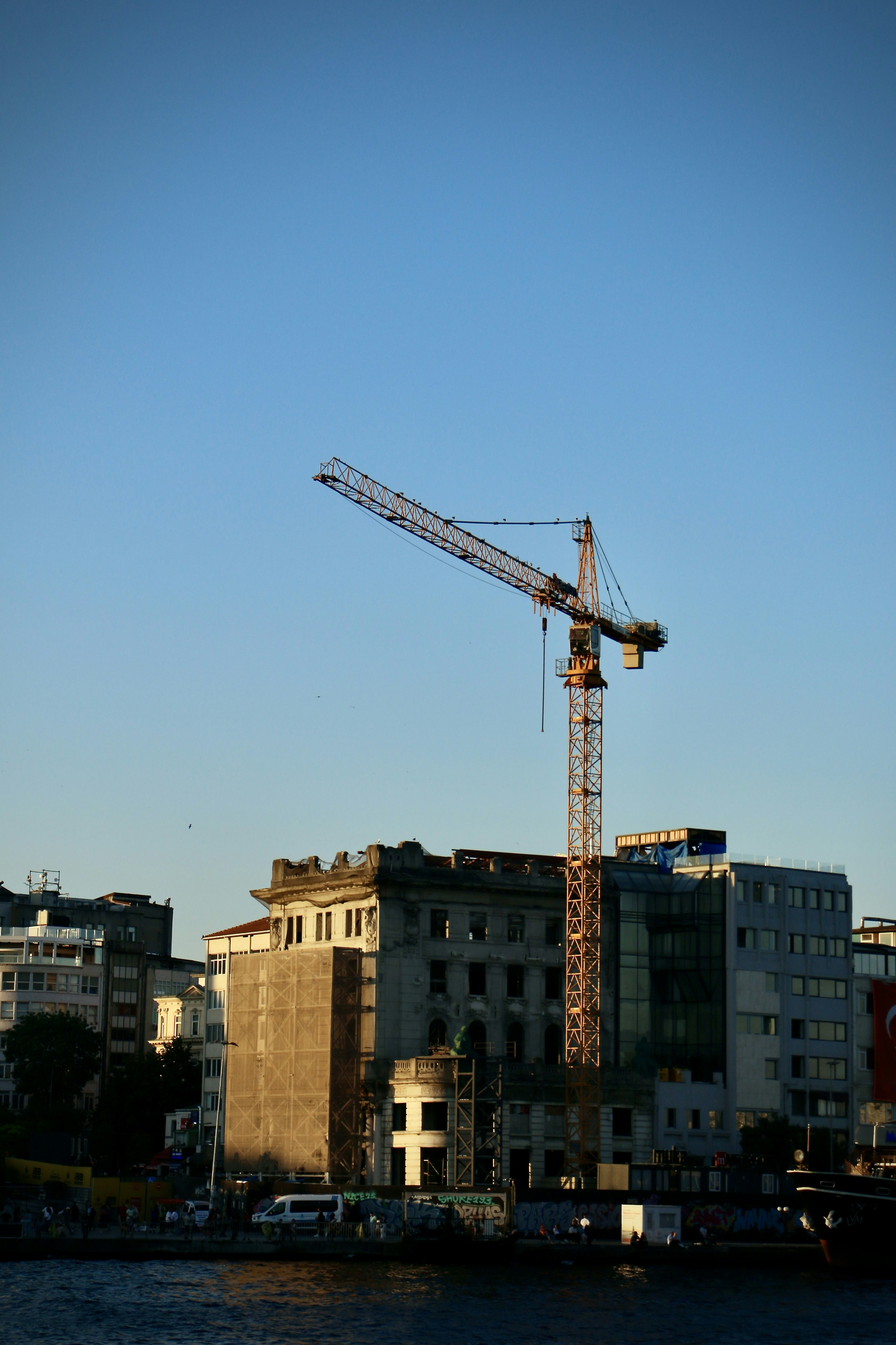 Construction crane against a clear blue sky.