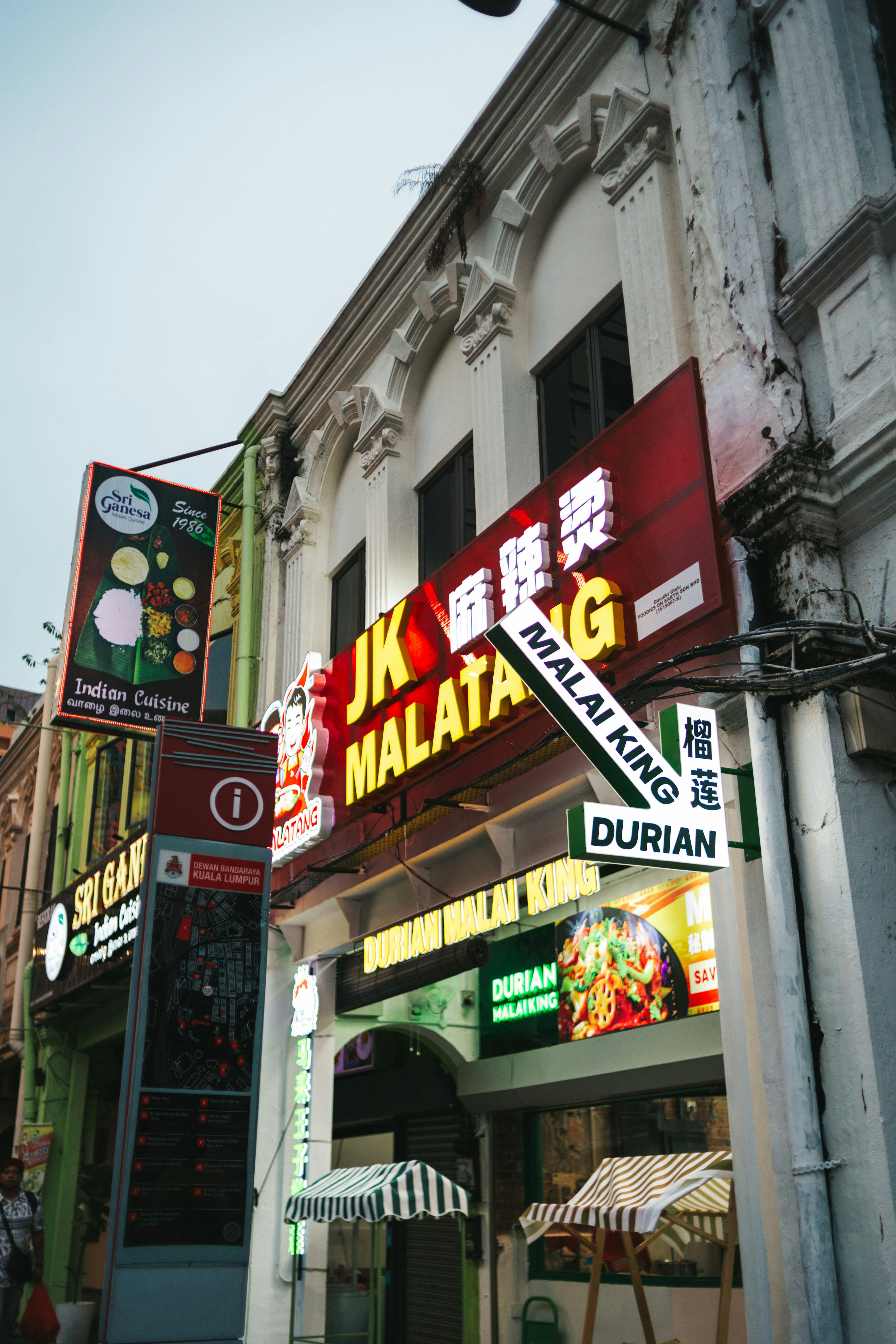 Street view of shops with signs in malaysia
