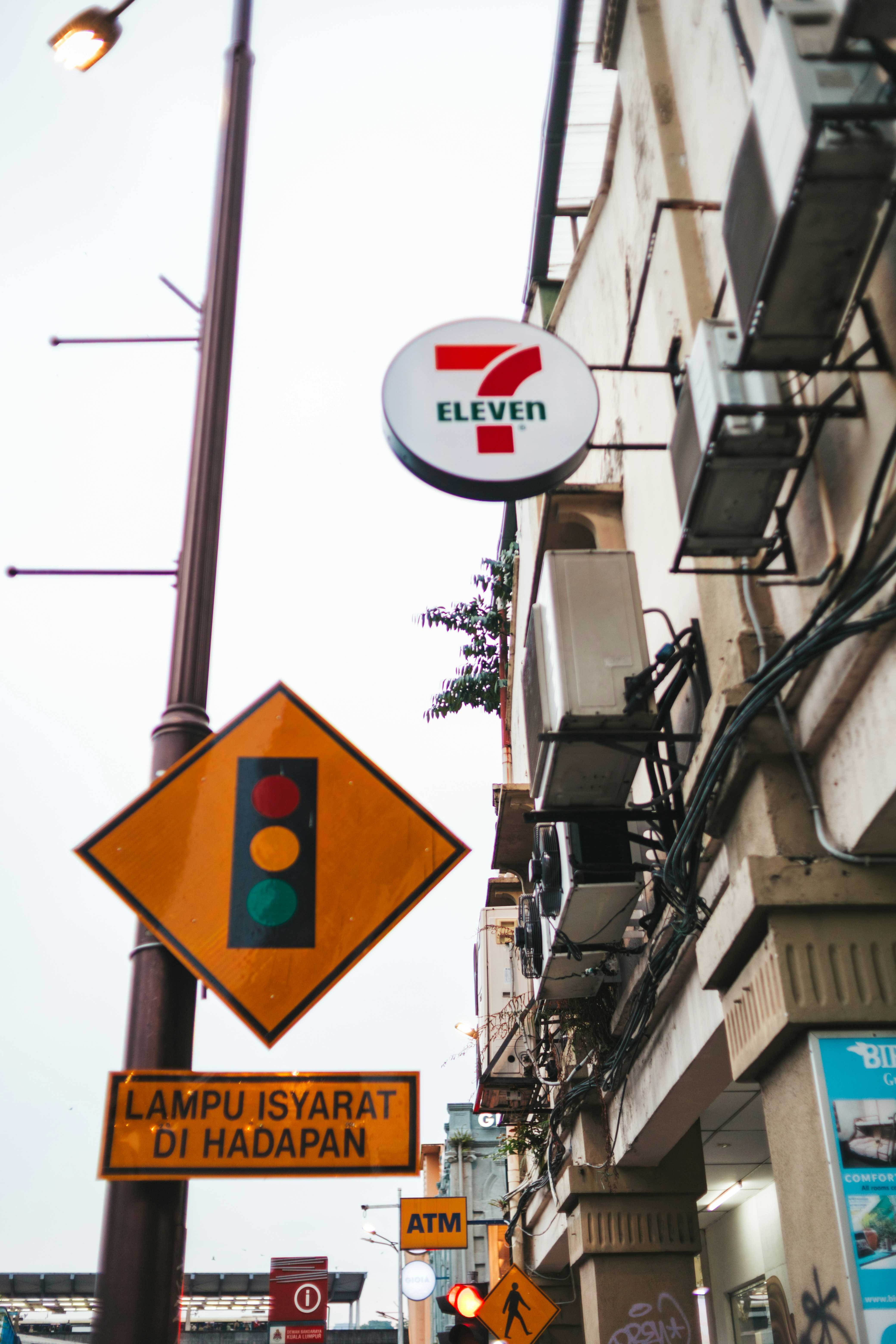 7-eleven sign and traffic signals on street