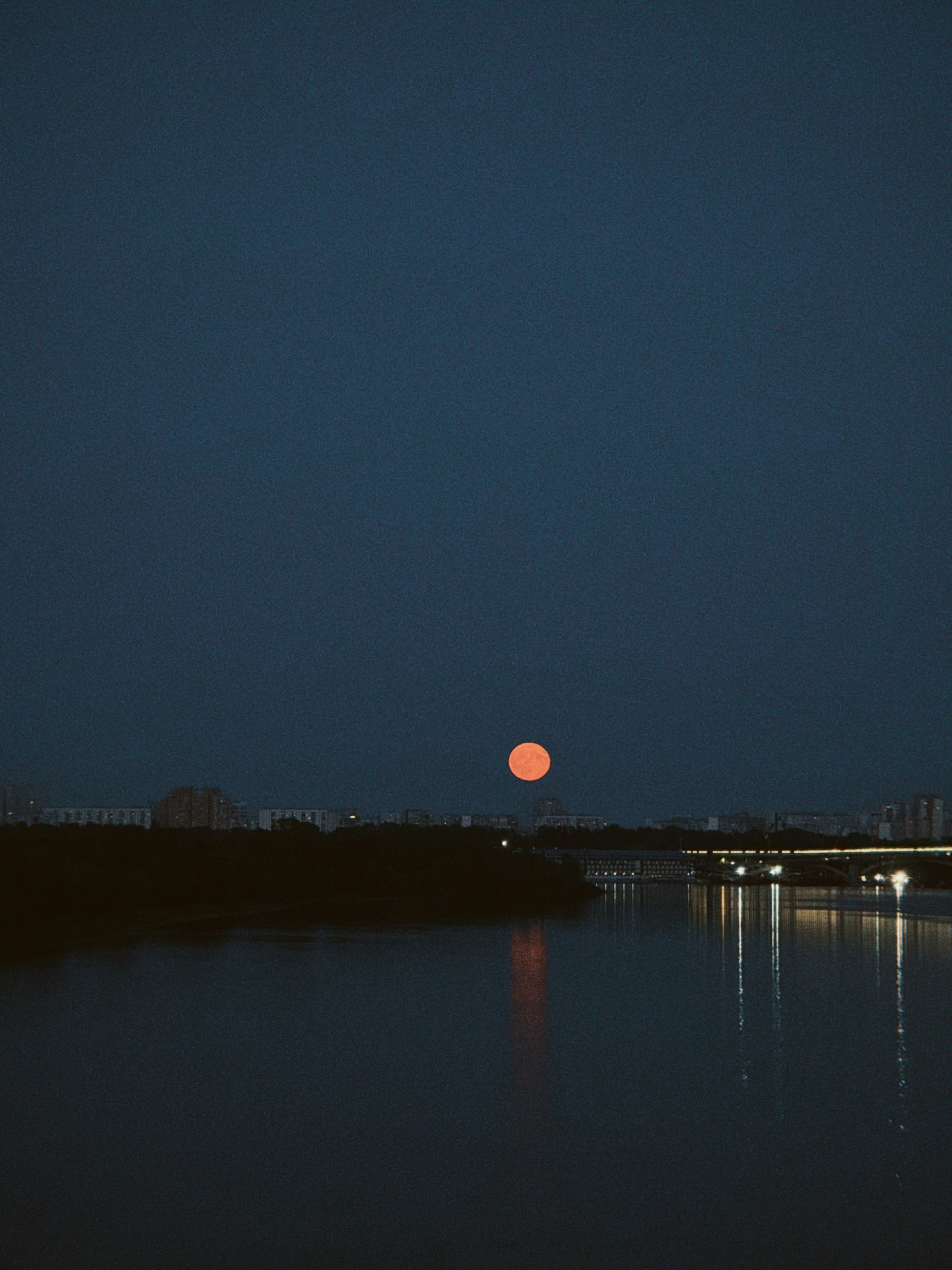 Moonlit Reflections Over Urban Waters