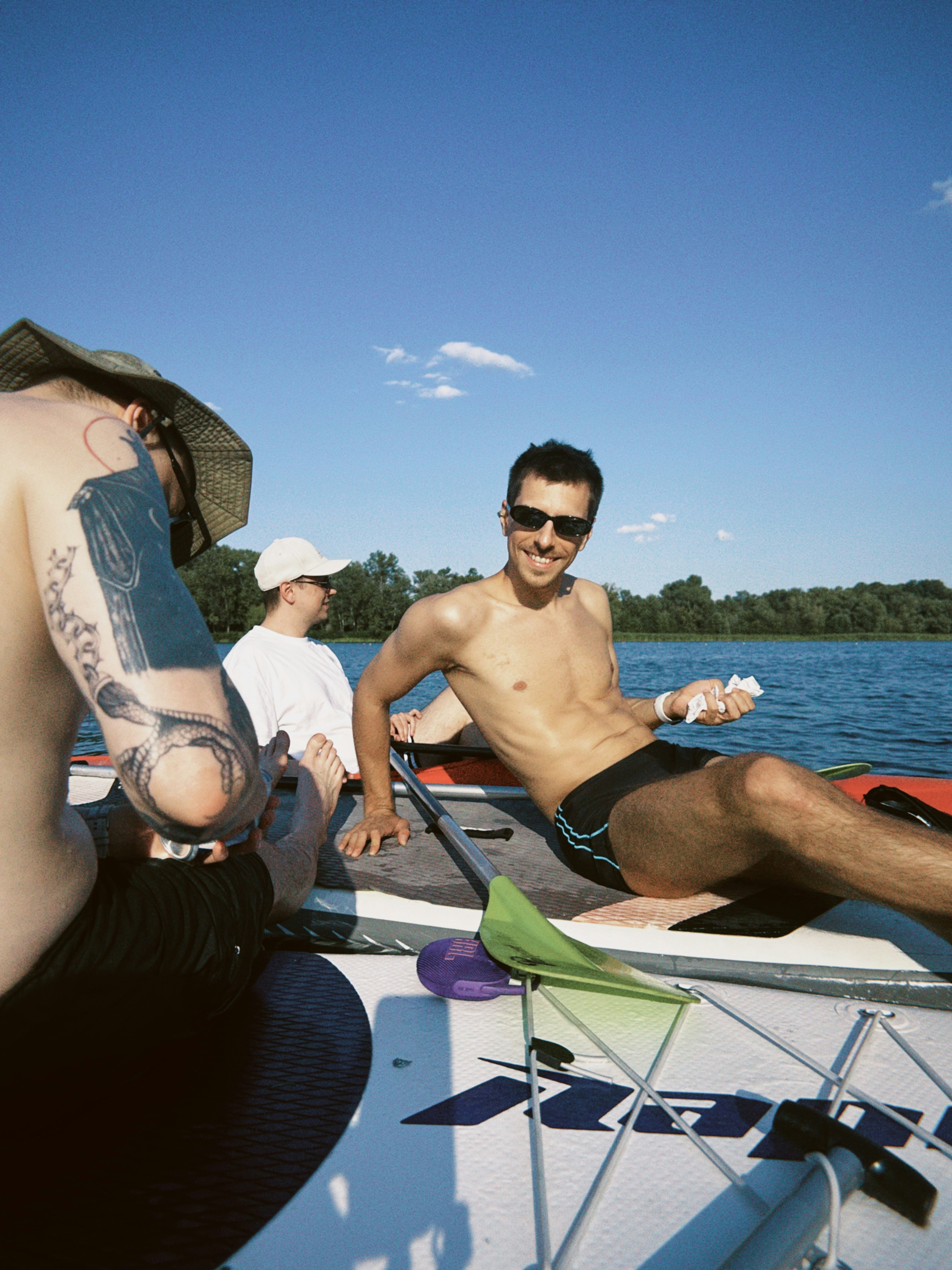 Men relaxing on paddleboards on a sunny day