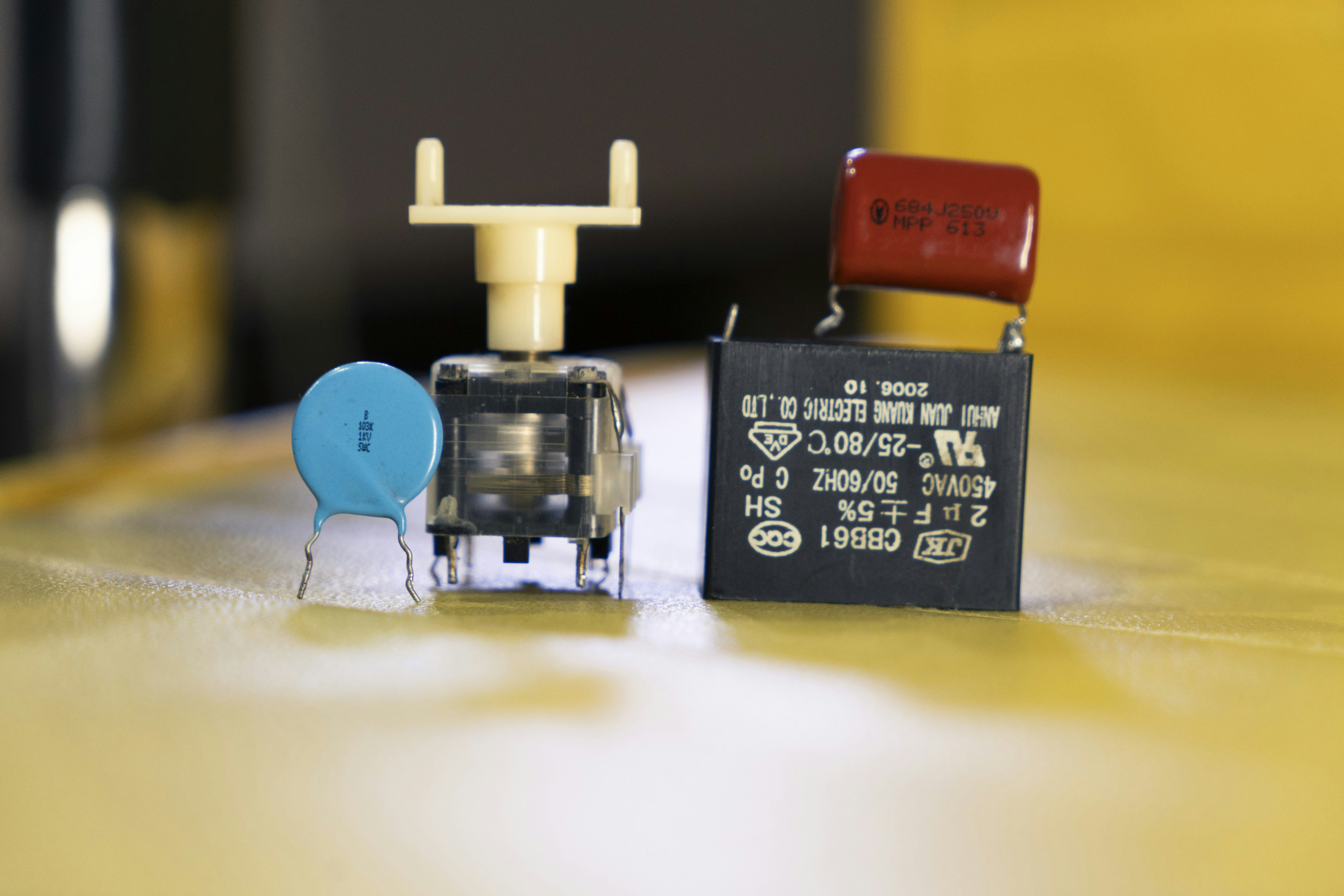 Two small electronic components on a wooden surface. photo – Free ...