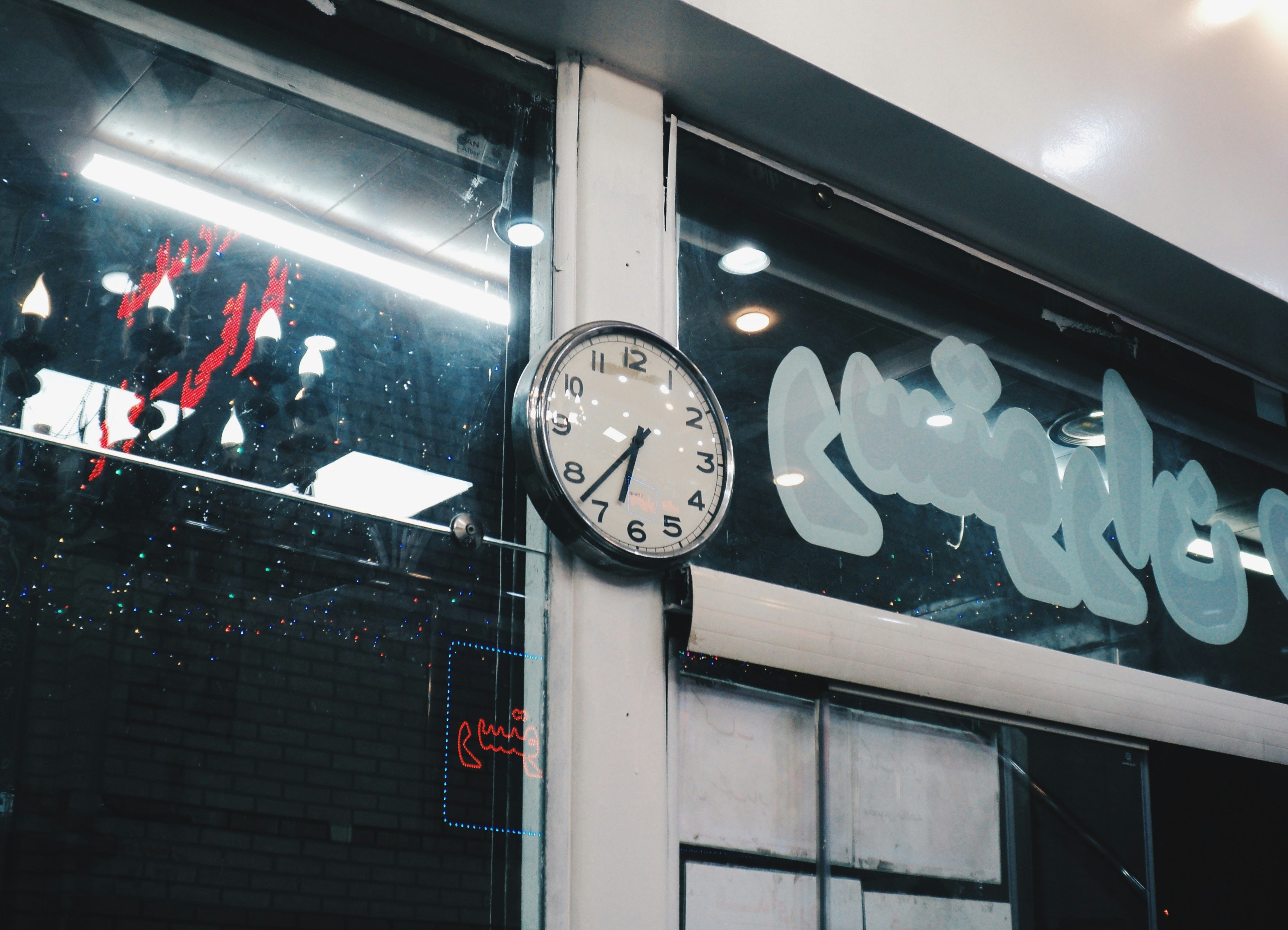 7:38 PM. The city is still breathing. | Round clock on a building facade
