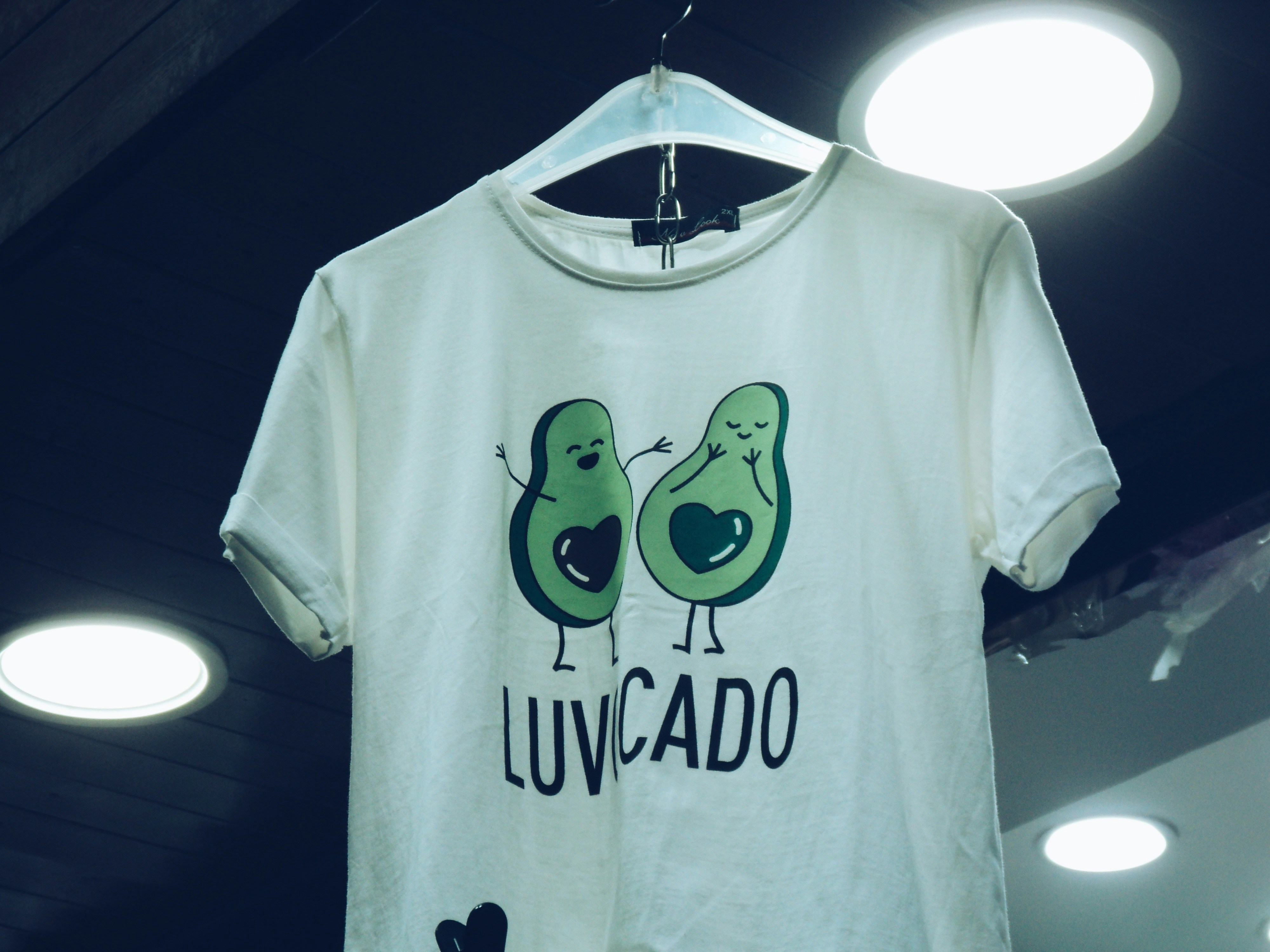 A little bit of green, a lot o.f love. | White t-shirt with avocado graphic and text