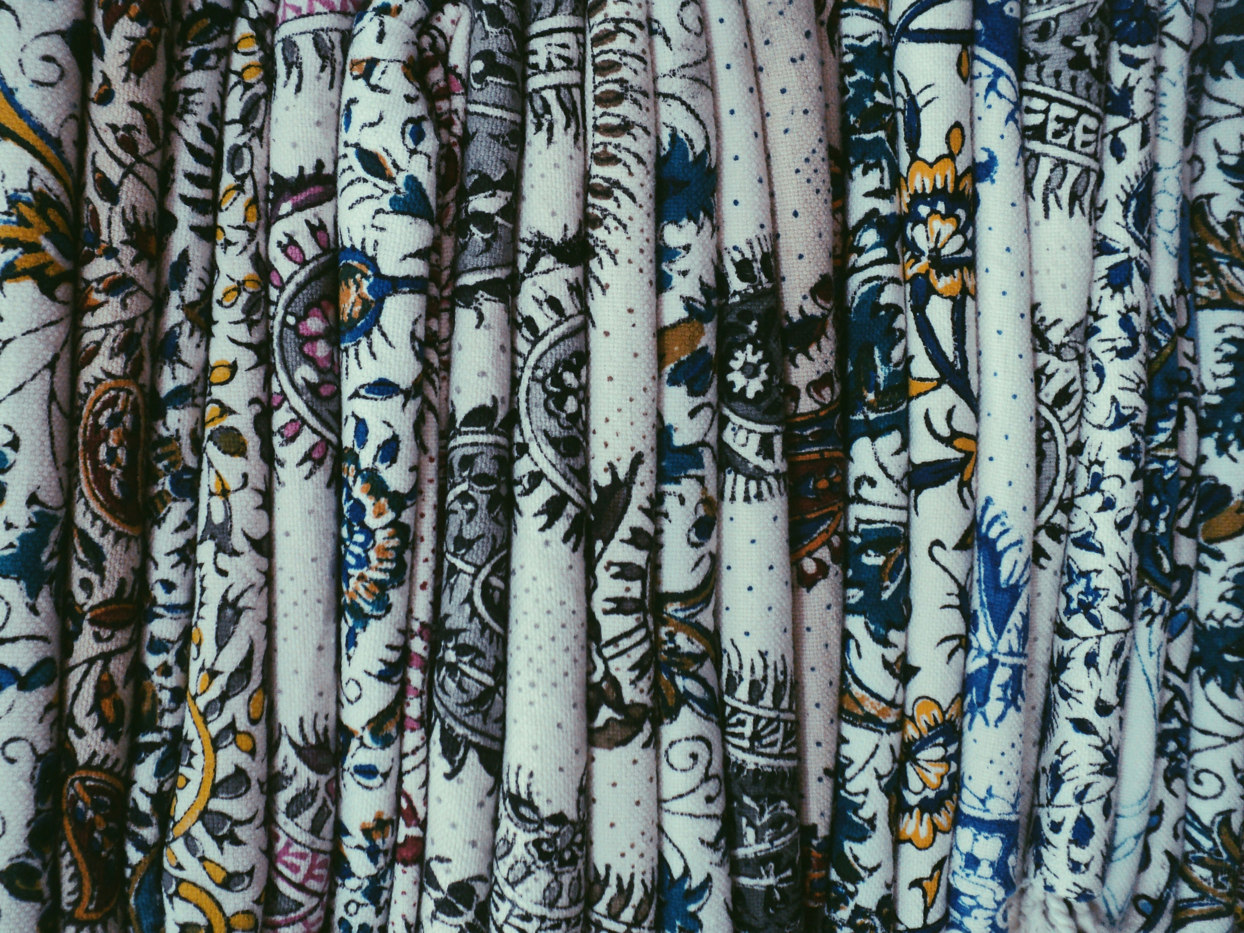A library of patterns. | Close up of patterned fabrics stacked vertically.