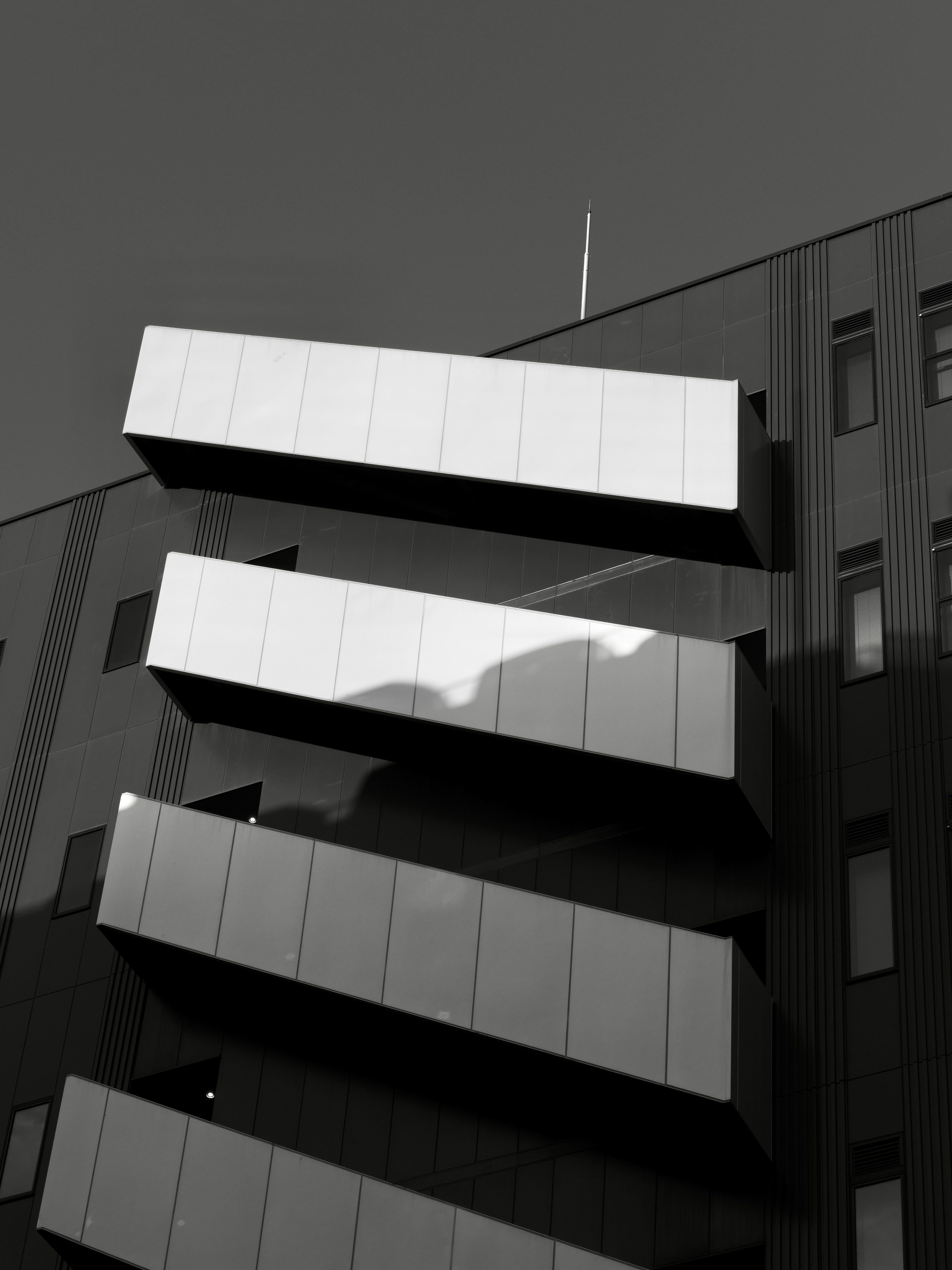 External staircase | Modern building with balconies against a clear sky