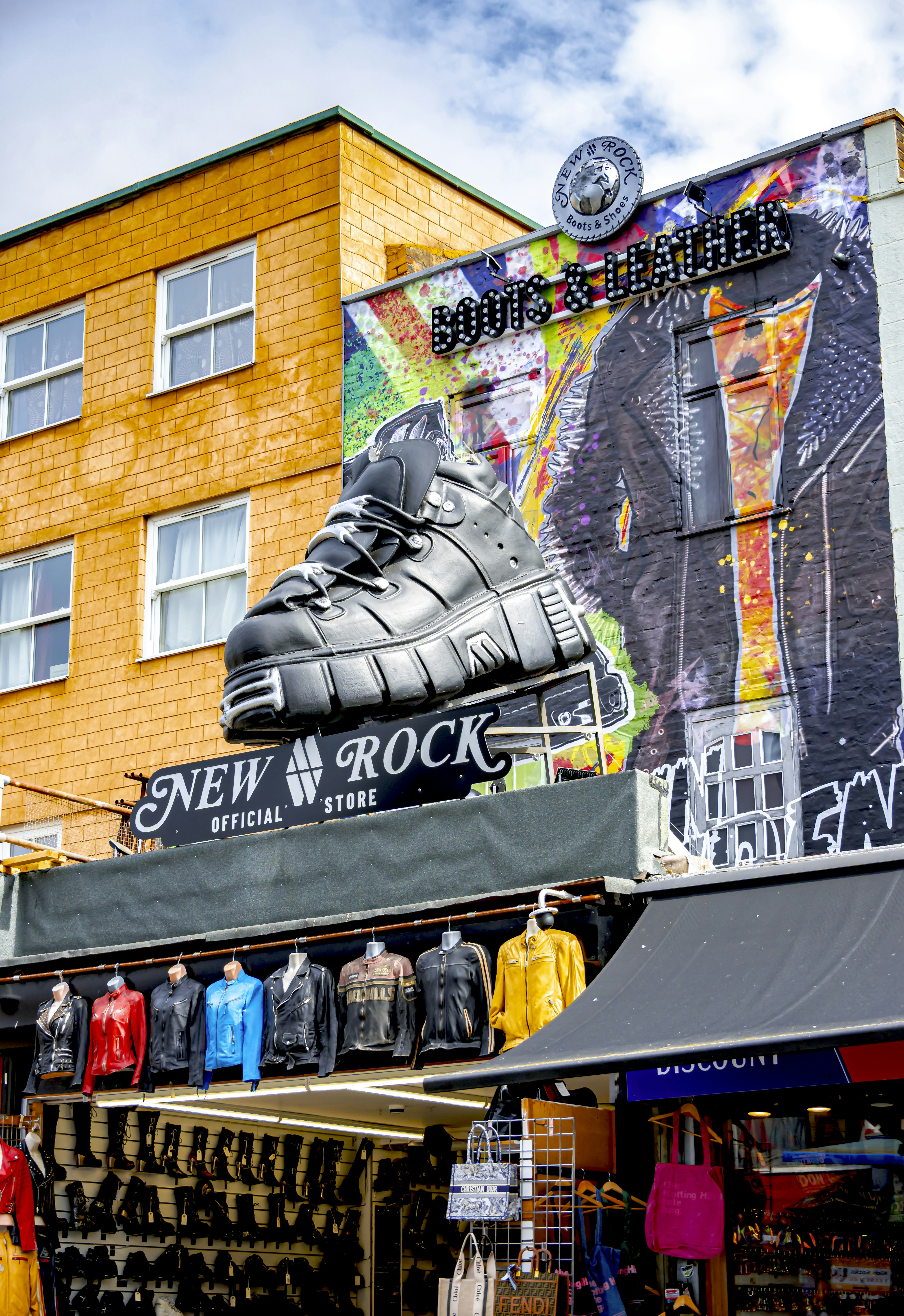 Giant Boot Over a Color-Splashed Storefront: New Rock Official Store