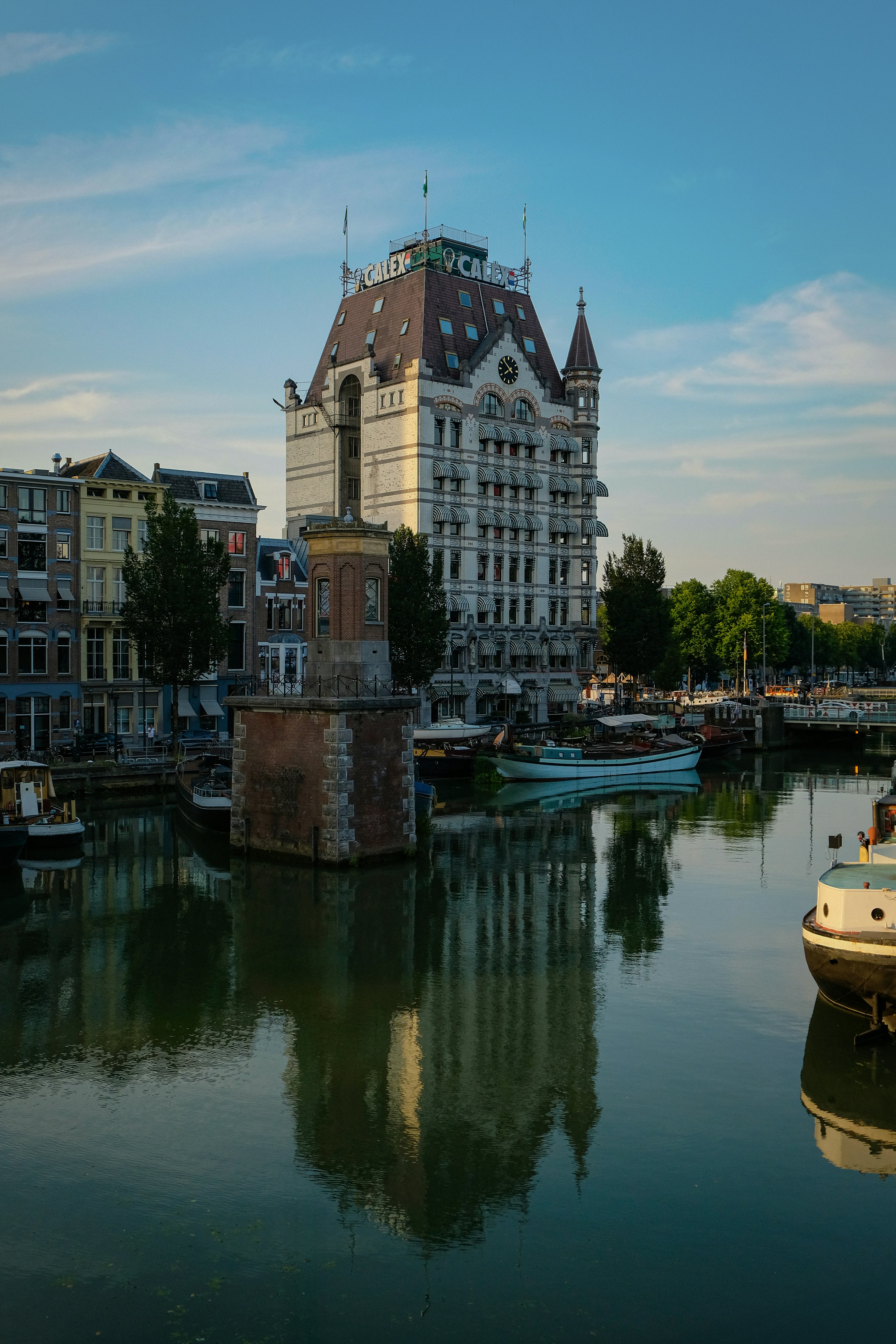 Summer night in Rotterdam, made these as my eye fell on how pretty the Oude Haven area is, a real treat! Hope you enjoy. | White building reflected in calm water with boats.