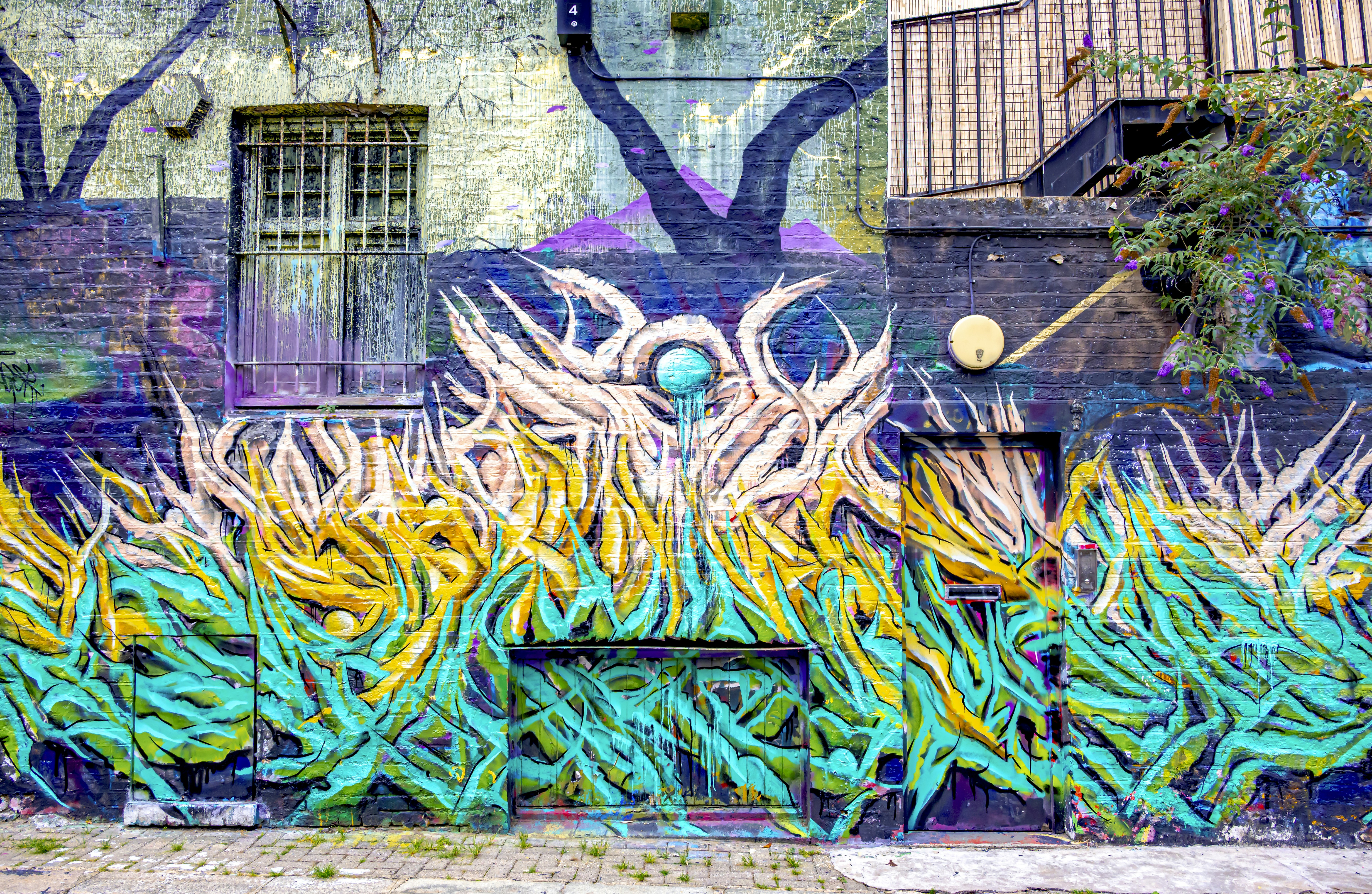 Chromatic Waves: A Vivid Graffiti Mosaic Across Urban Brick