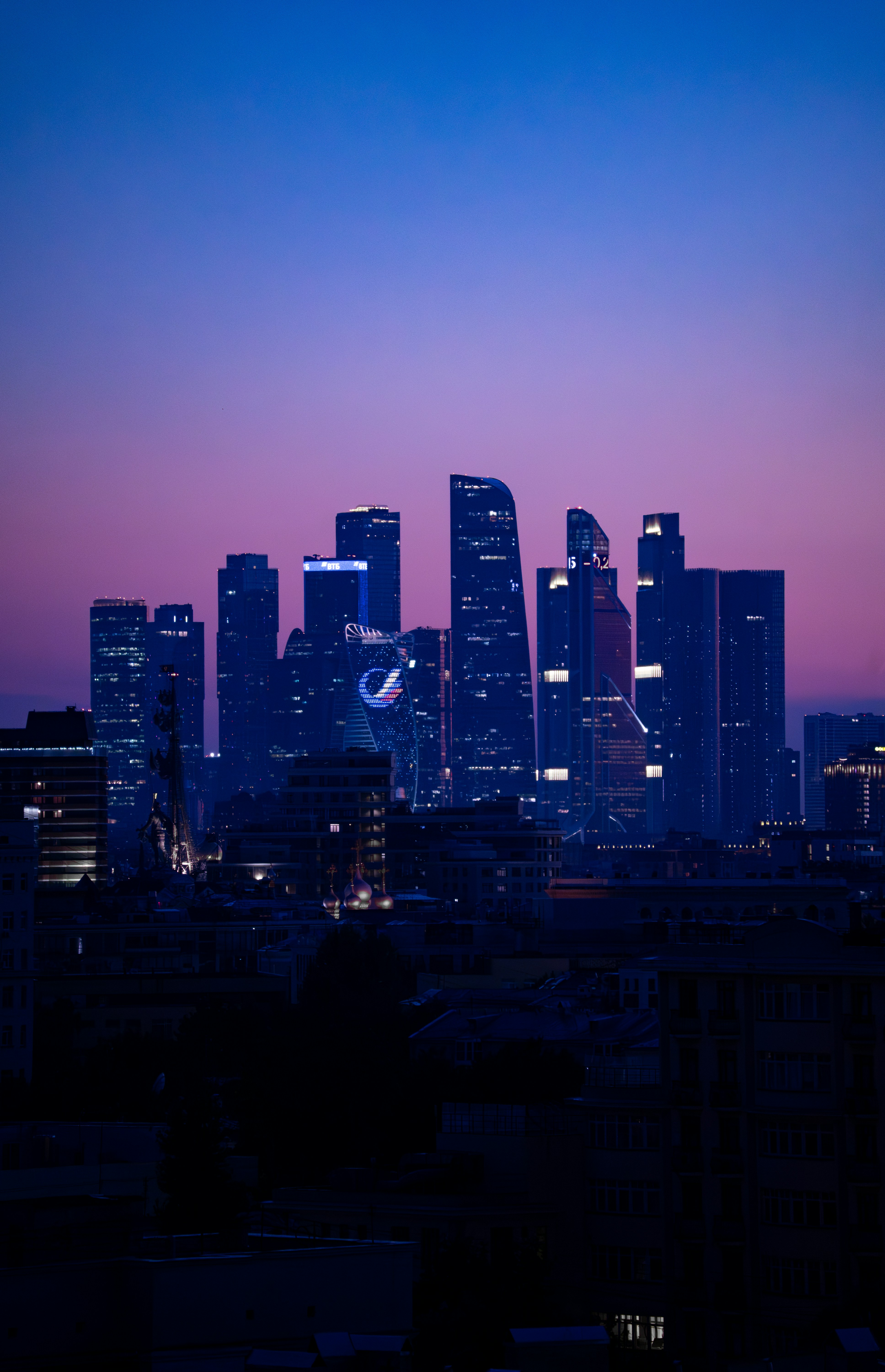 City skyline illuminated against a twilight sky