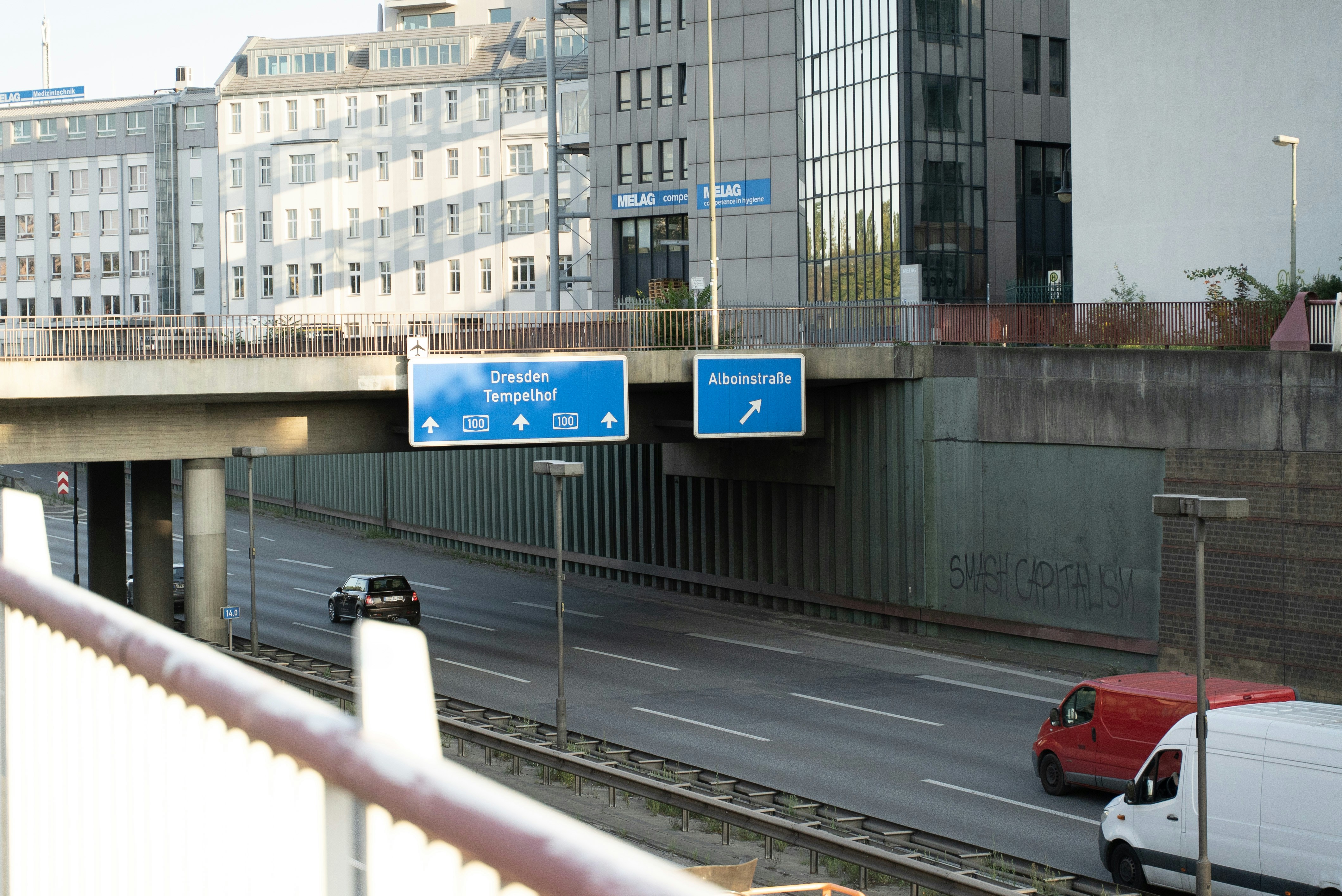 Truck on highway with city buildings in background