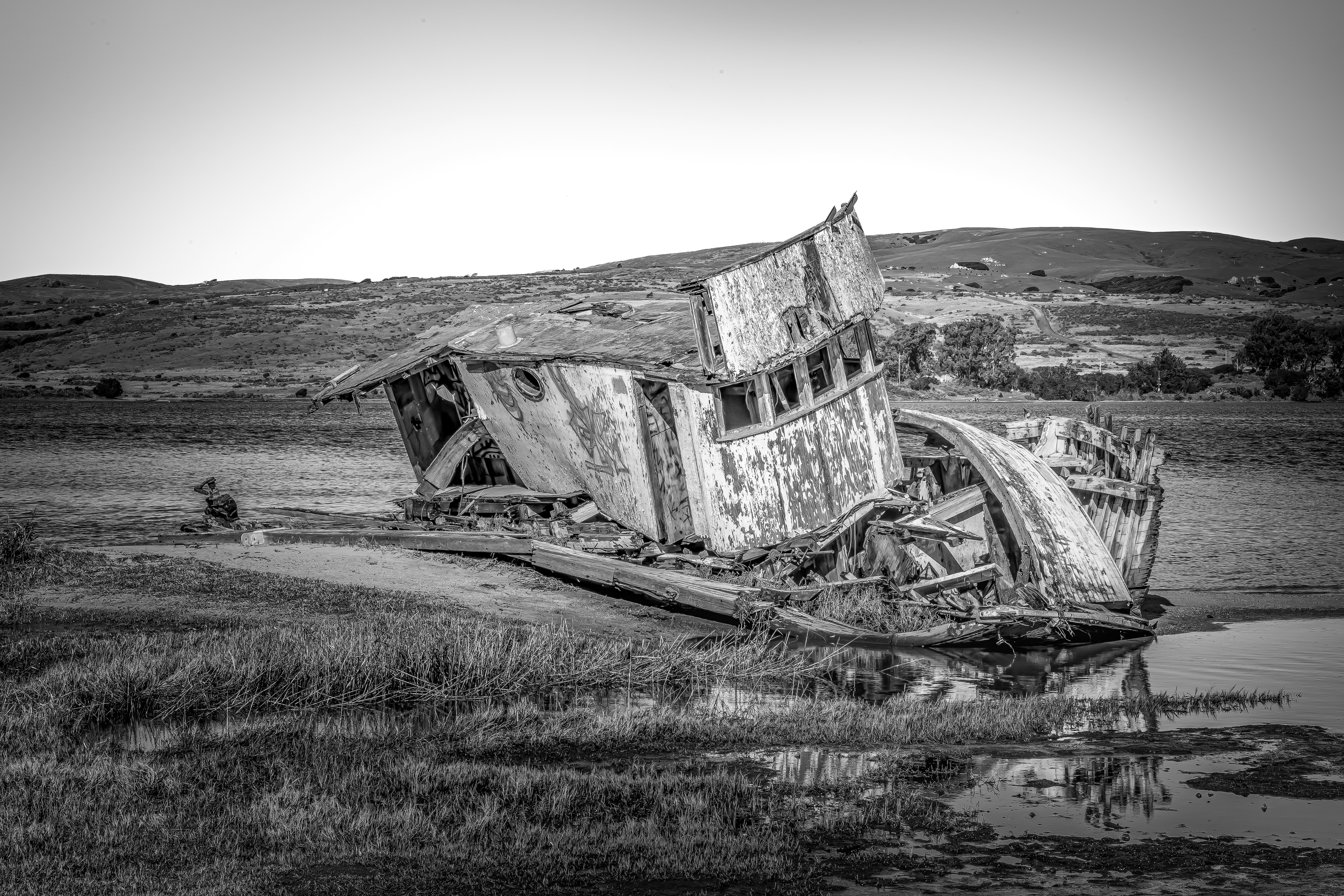 Abandoned shipwreck on a calm body of water