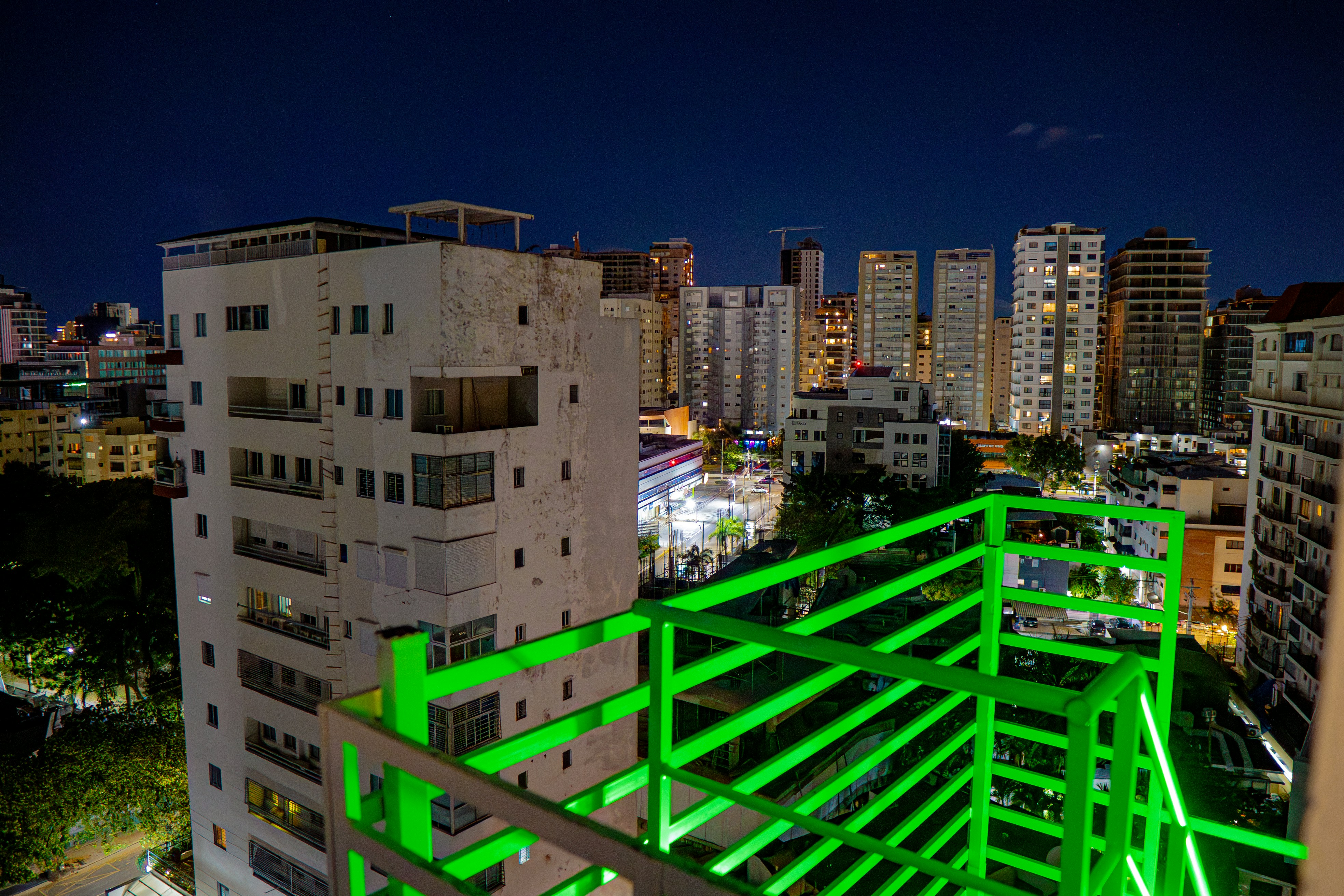 Illuminated city skyline at night with modern buildings.