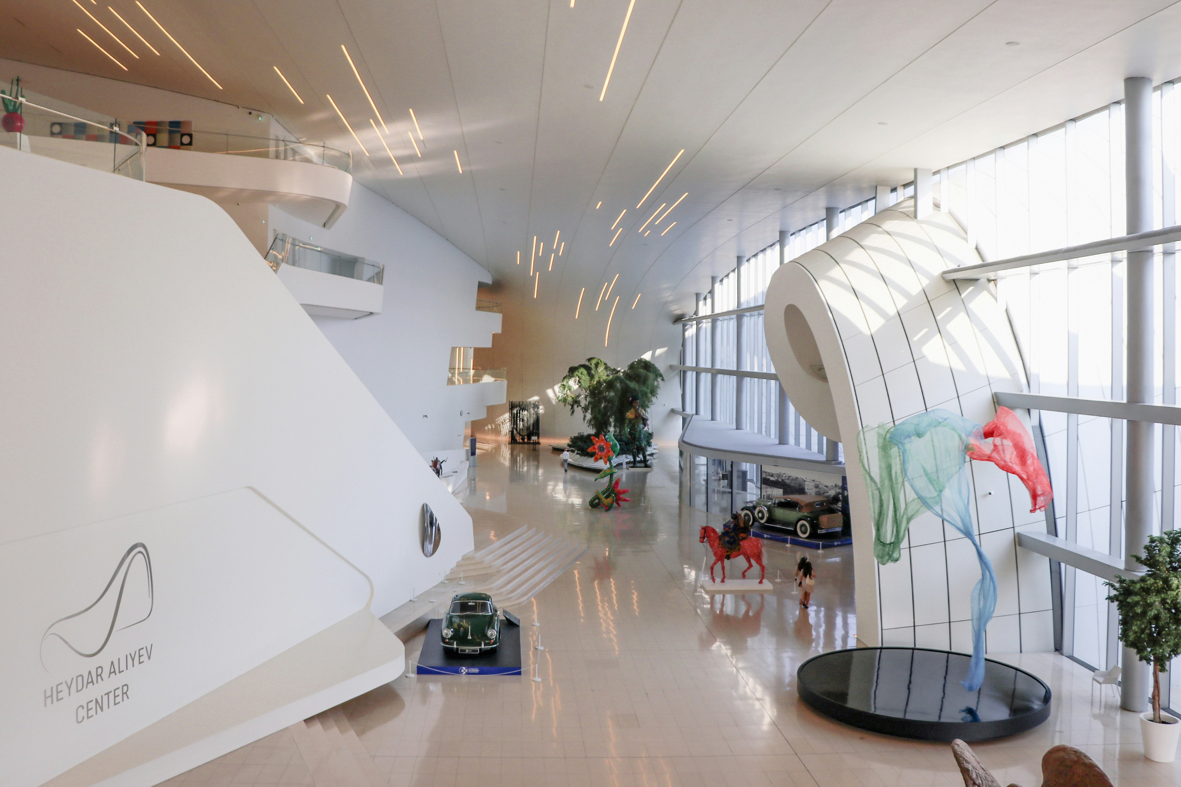 Modern office interior with large windows and plants.