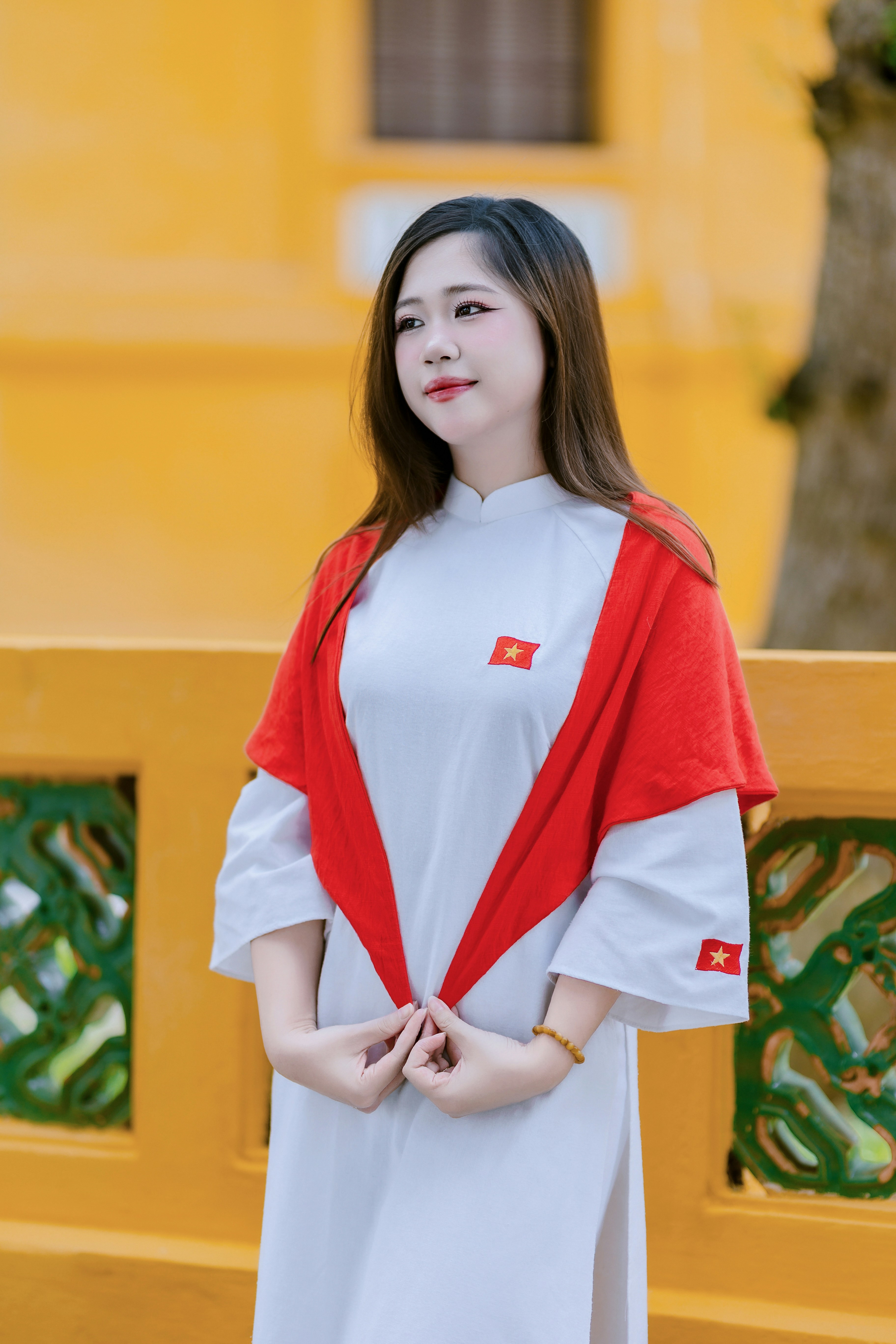 Vietnamese girl in ao dai celebrates national day | Young woman in traditional vietnamese dress outdoors