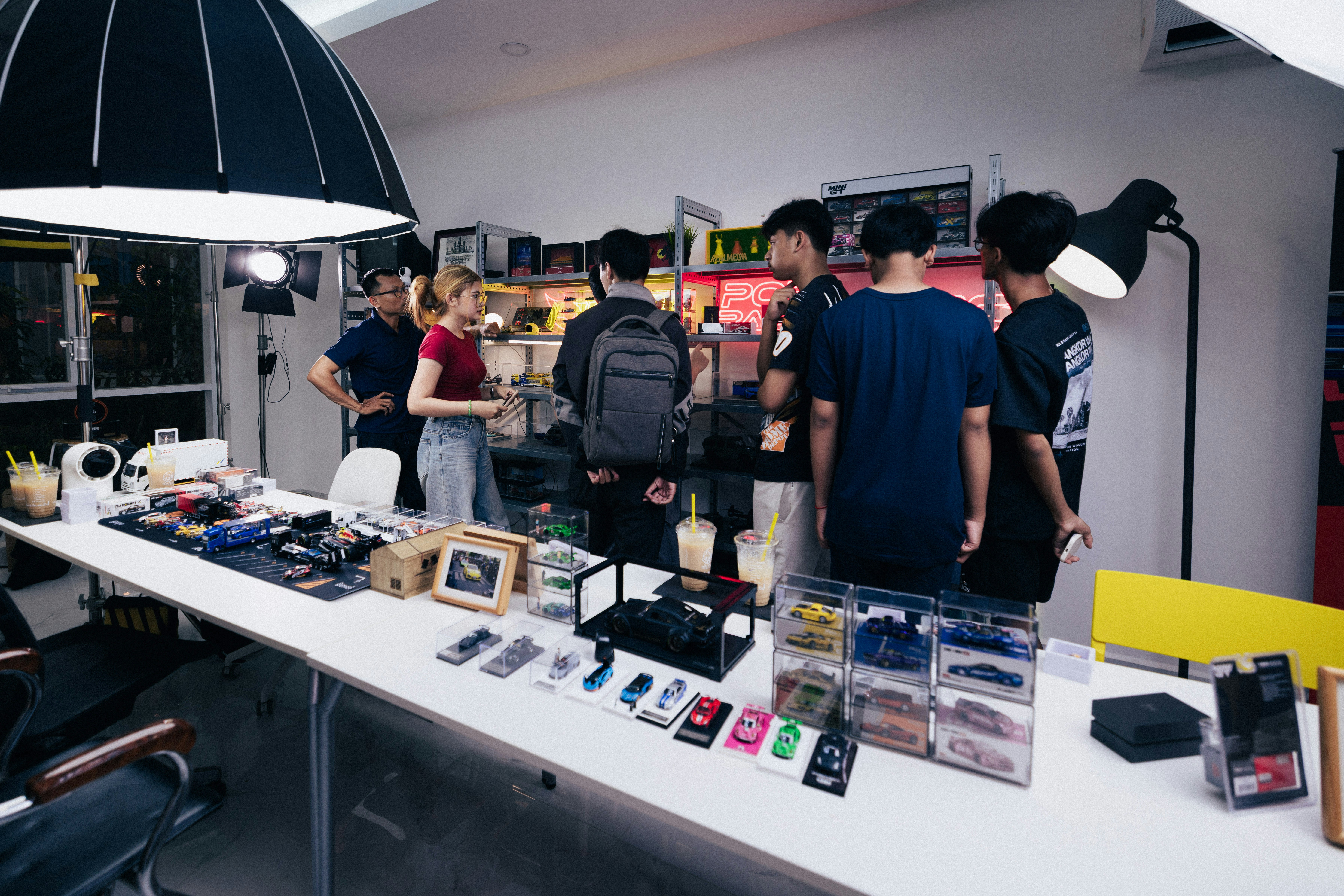 Car event meeting at RC Cambodia | People gathered around a table in a workshop