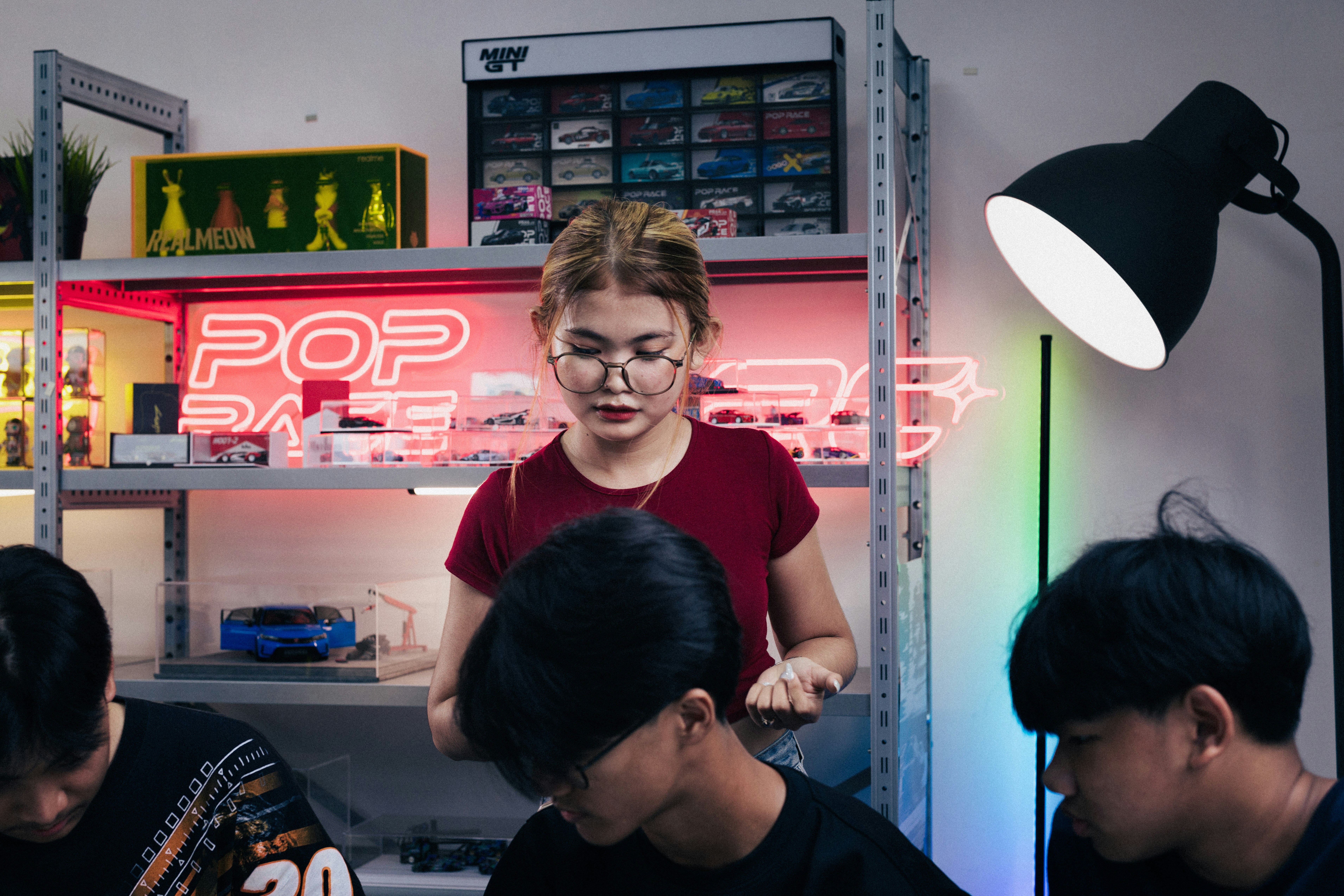 Neon-lit Mentor Oversees a Car-Model Workshop