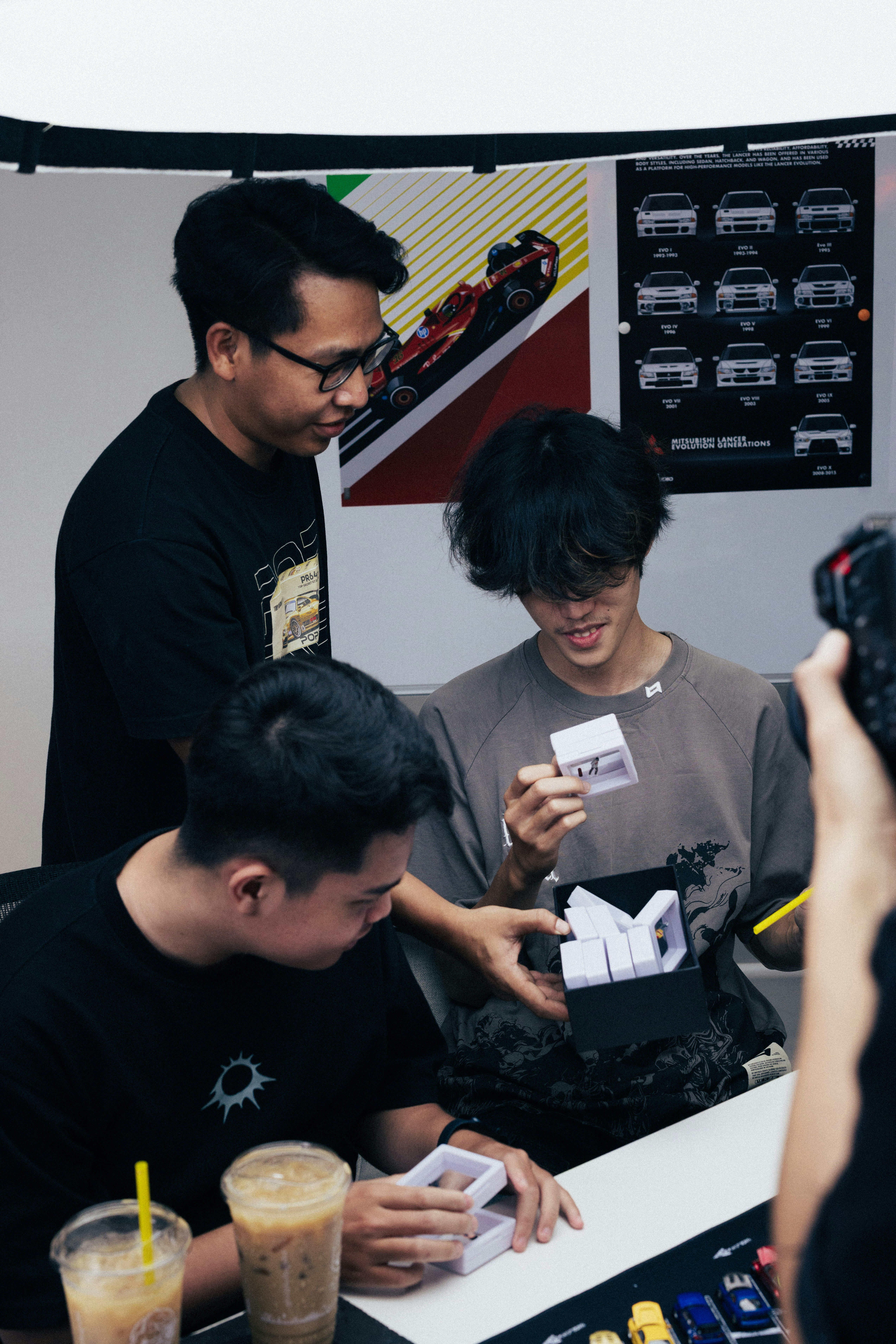 Diecast Collector Cambodia meeting by RC Cambodia | Group of friends looking at something together at something on a table