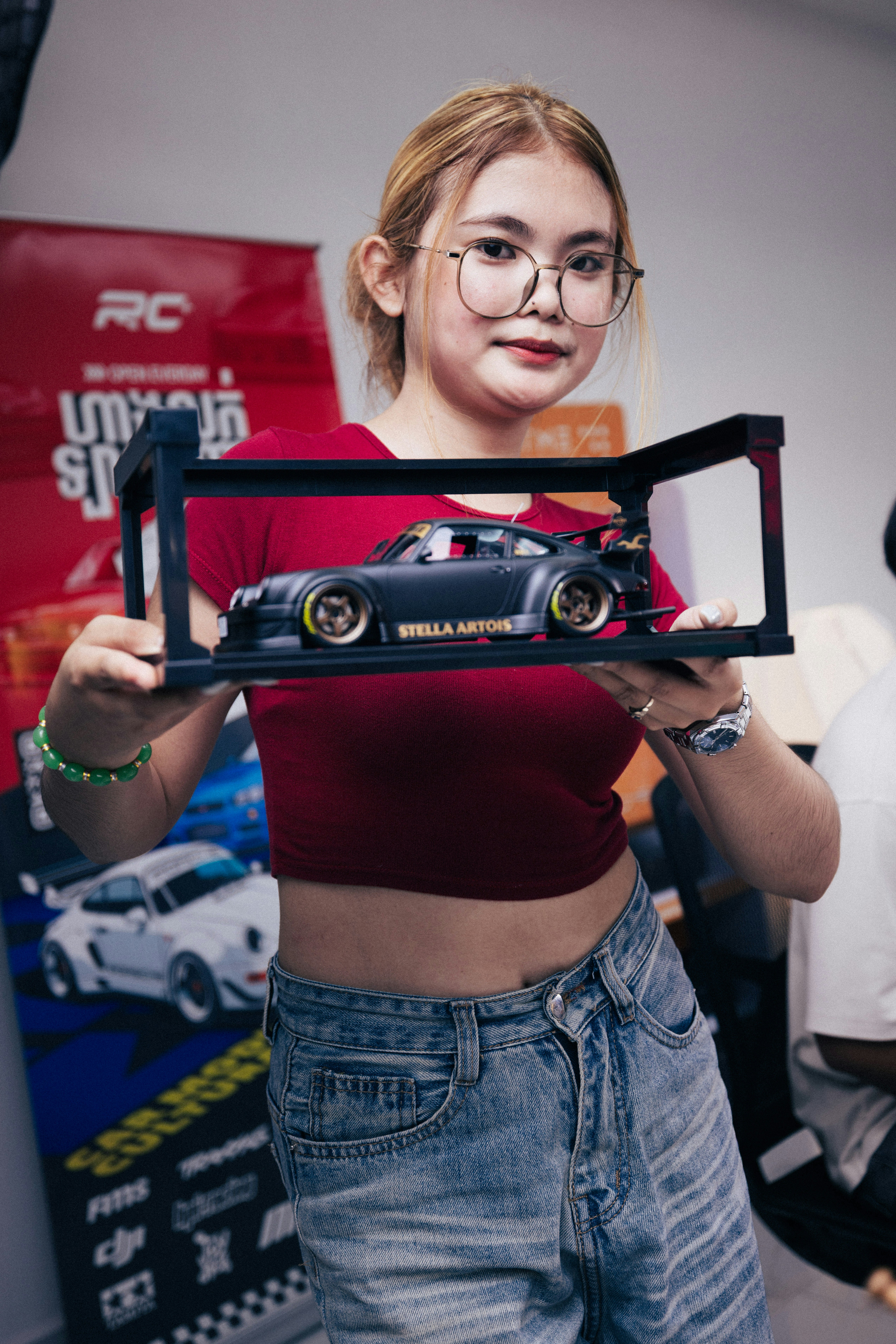 Diecast Collector Cambodia meeting by RC Cambodia | Young woman holding a model car in a display frame