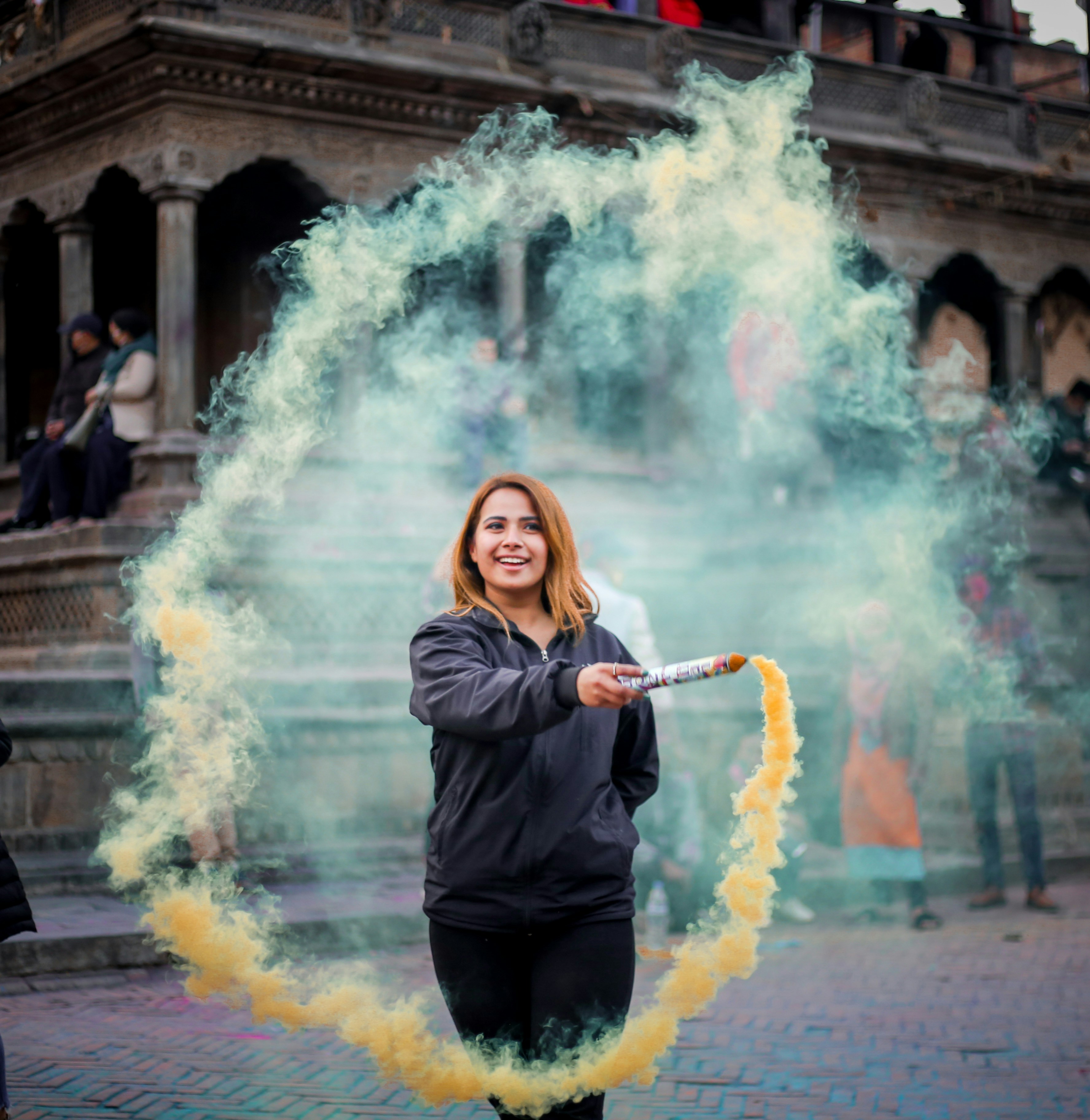 Colors of Heritage and Expression | Woman creates a colorful smoke ring with sparklers.