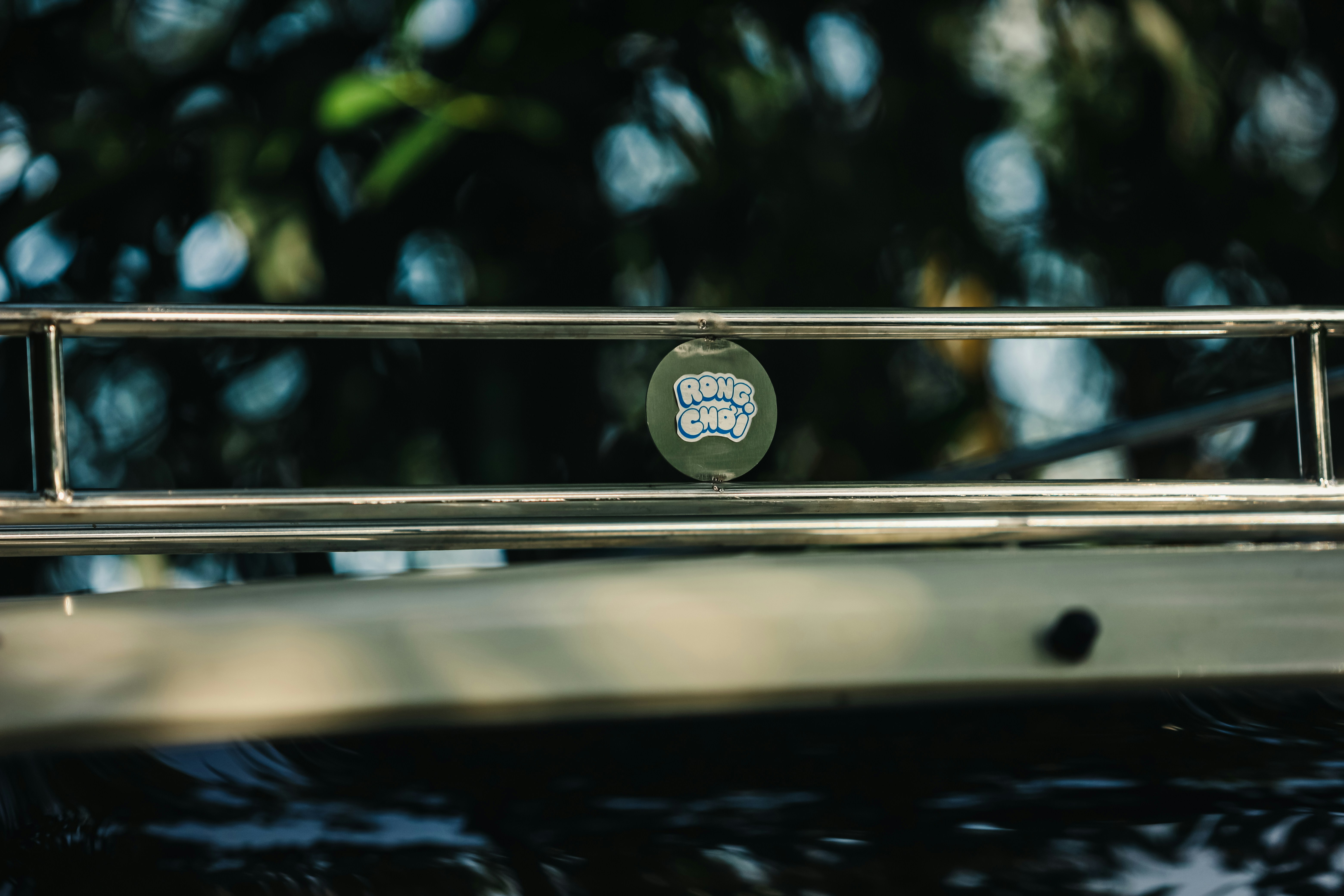 Close-up of a silver car roof rack with emblem.