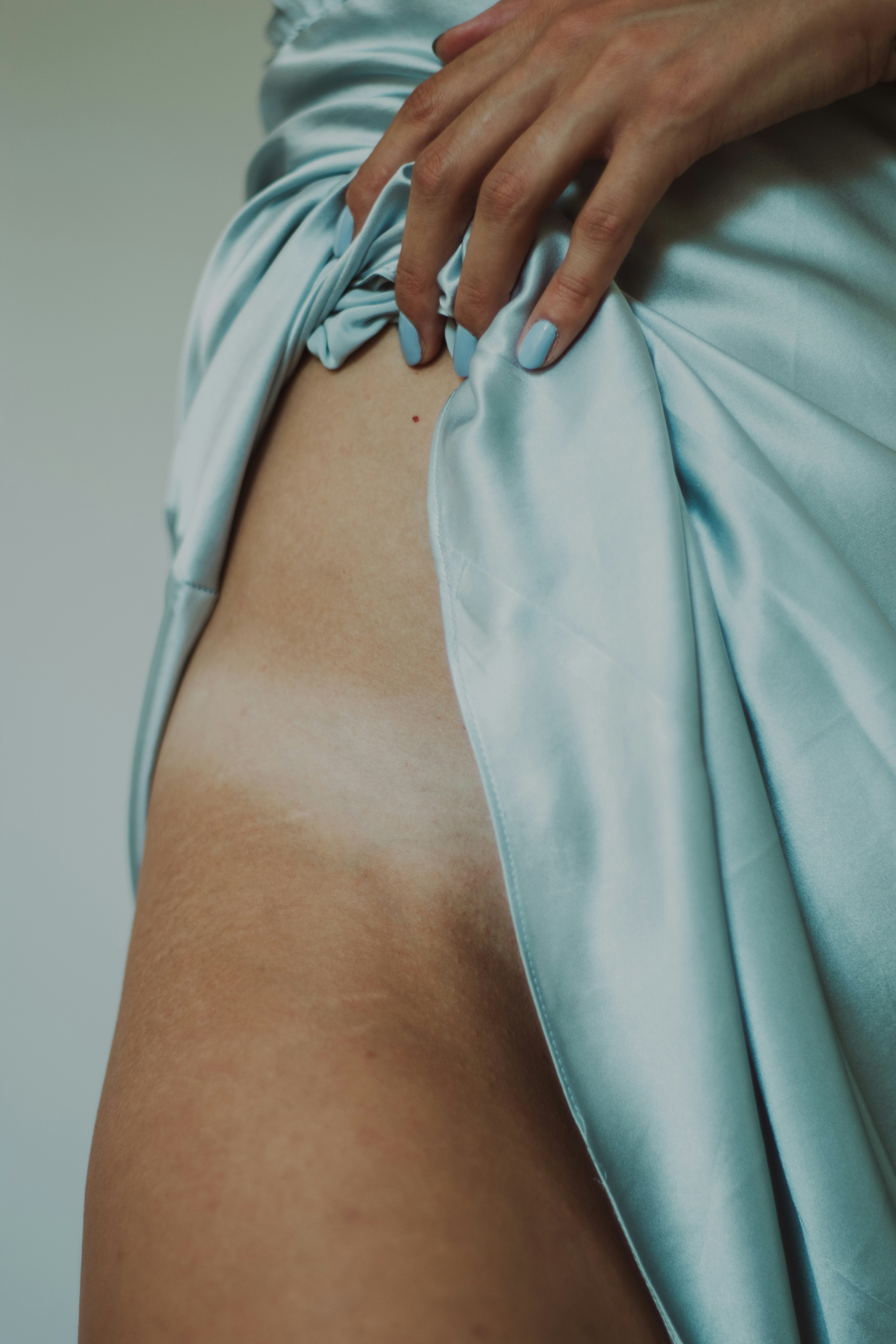 Woman in light blue dress with tan lines