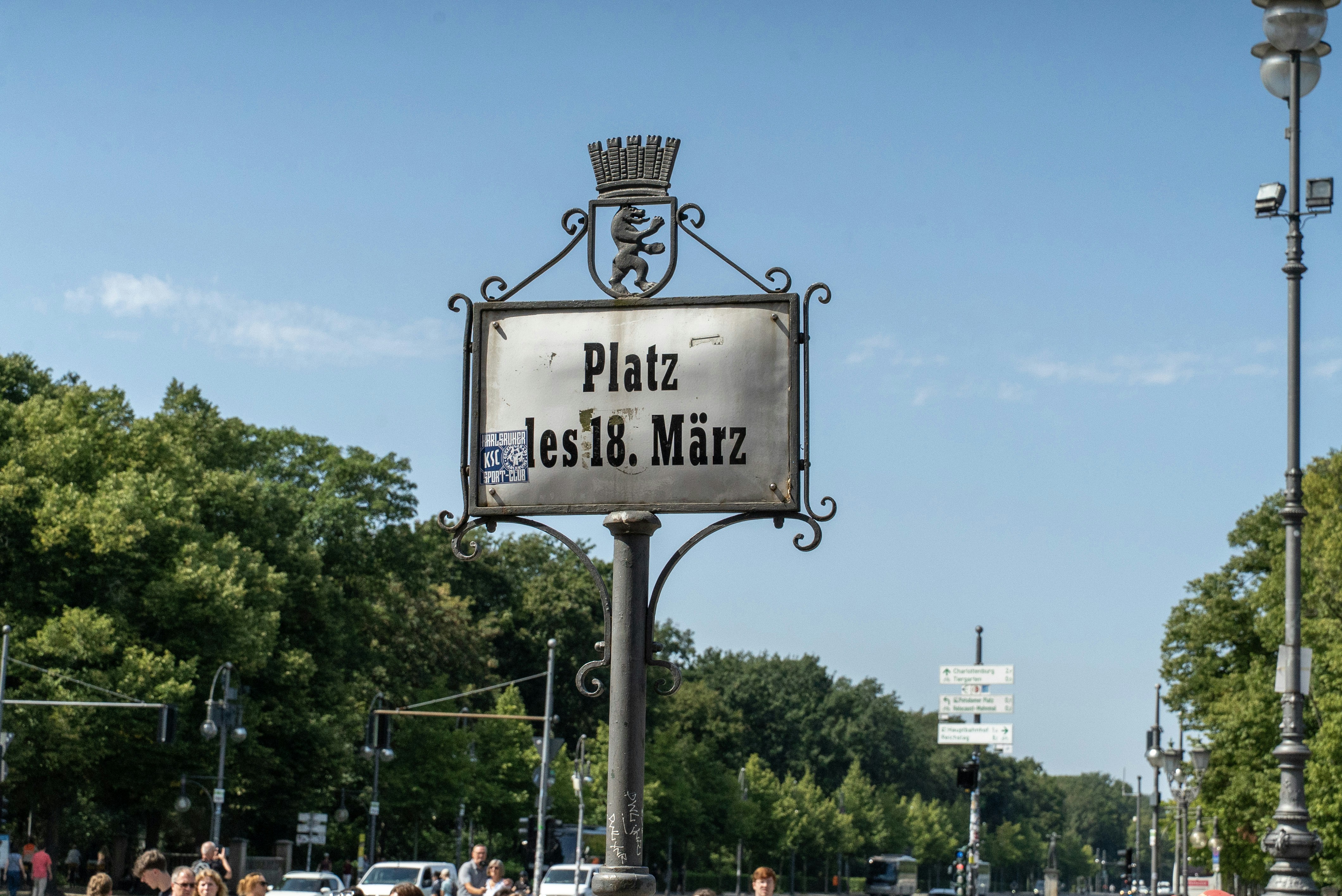 Street sign with trees and blue sky