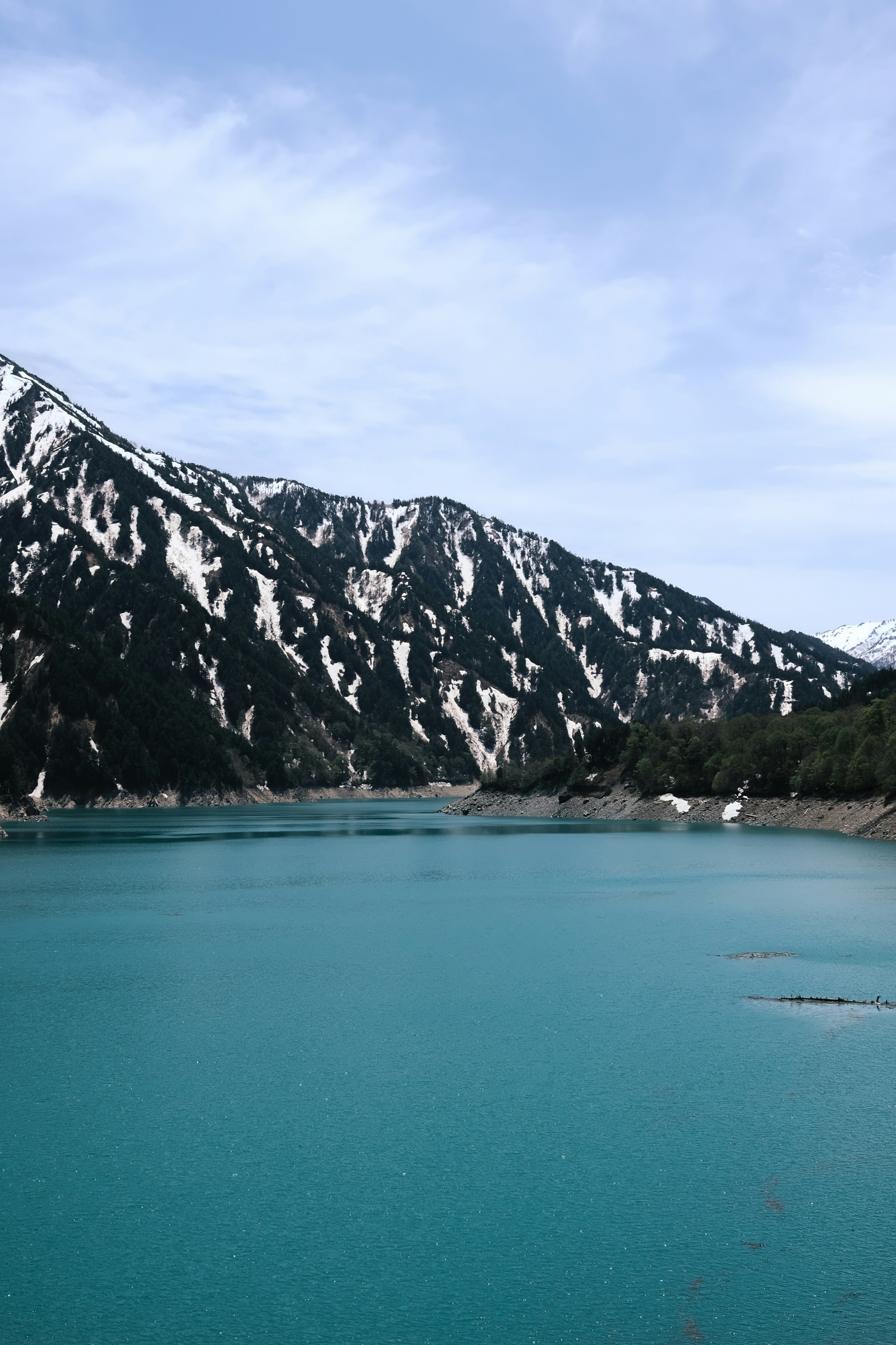 Emerald Waters Embracing Mountain Shadows