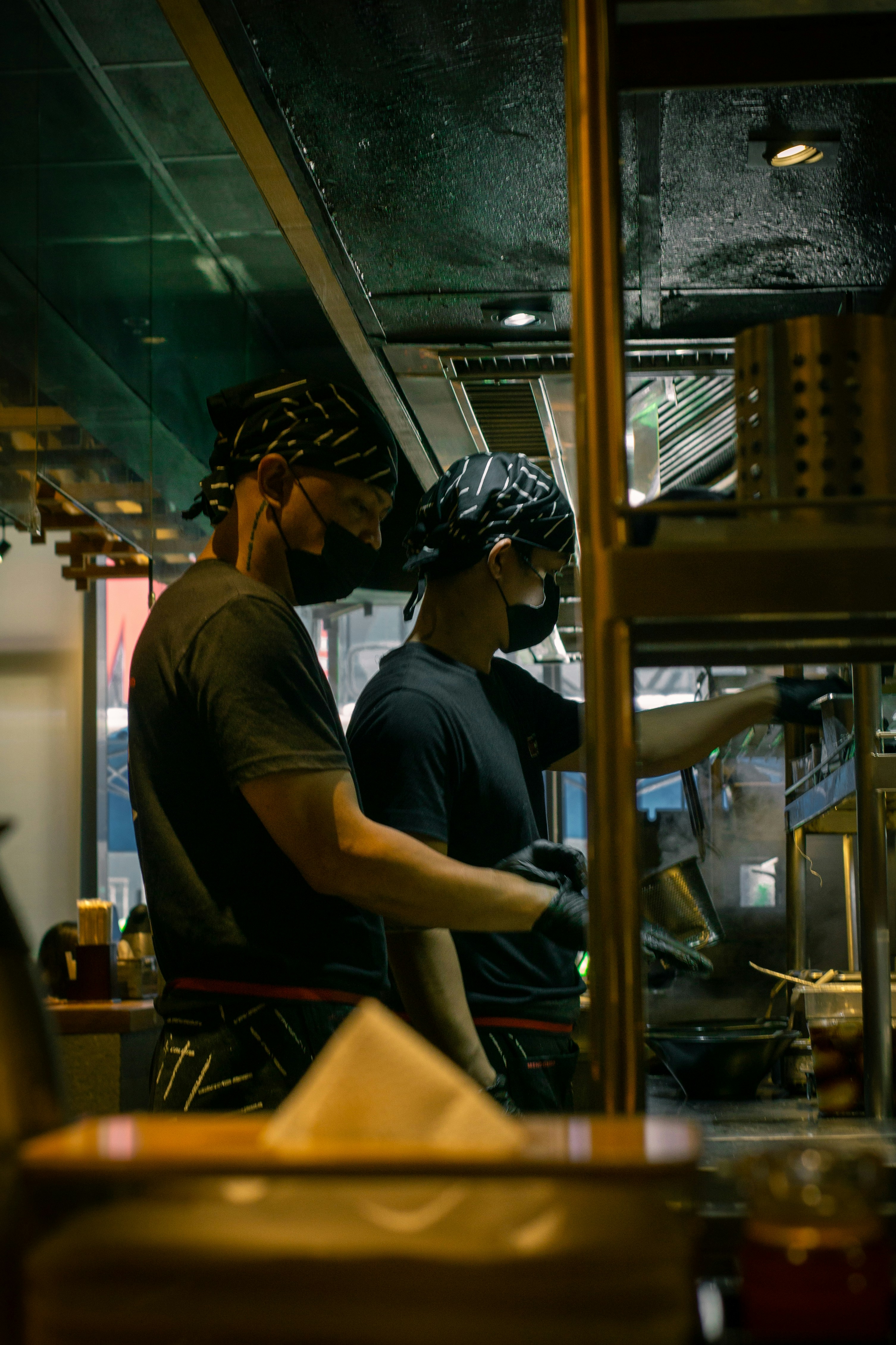Two chefs working in a busy kitchen