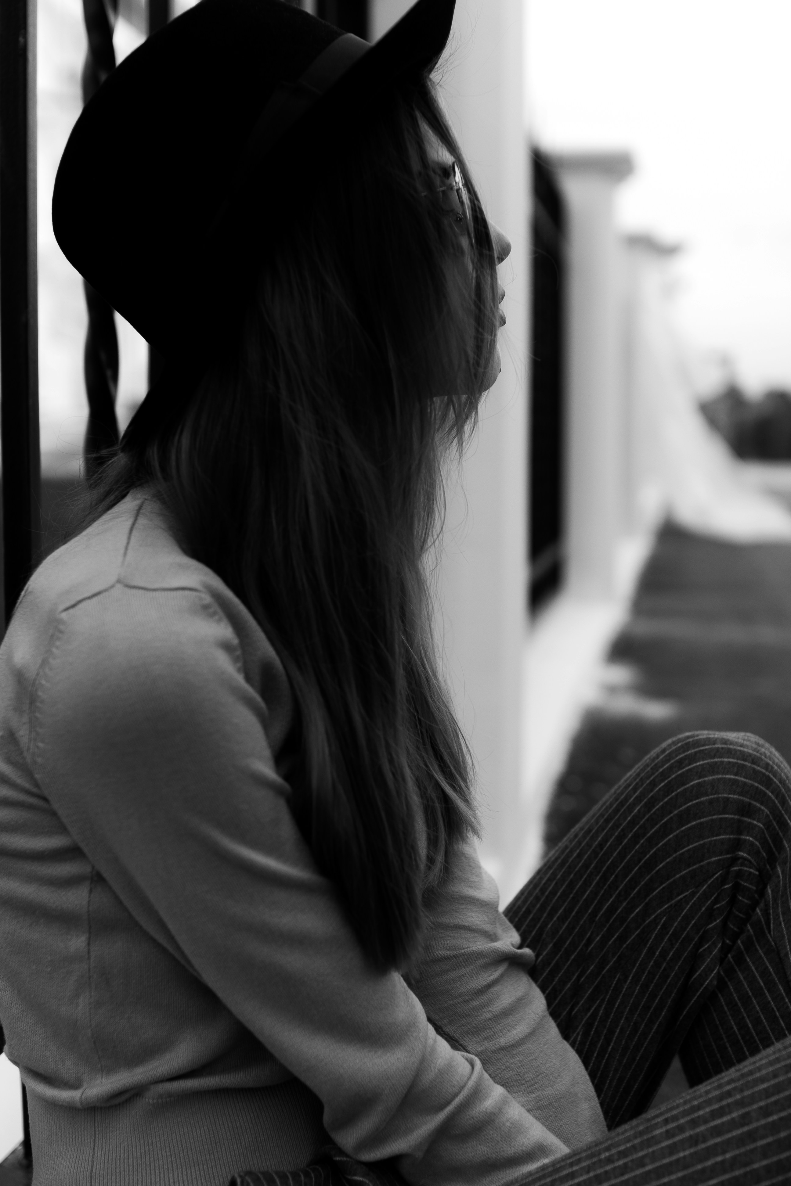 Woman wearing a baseball cap looking up
