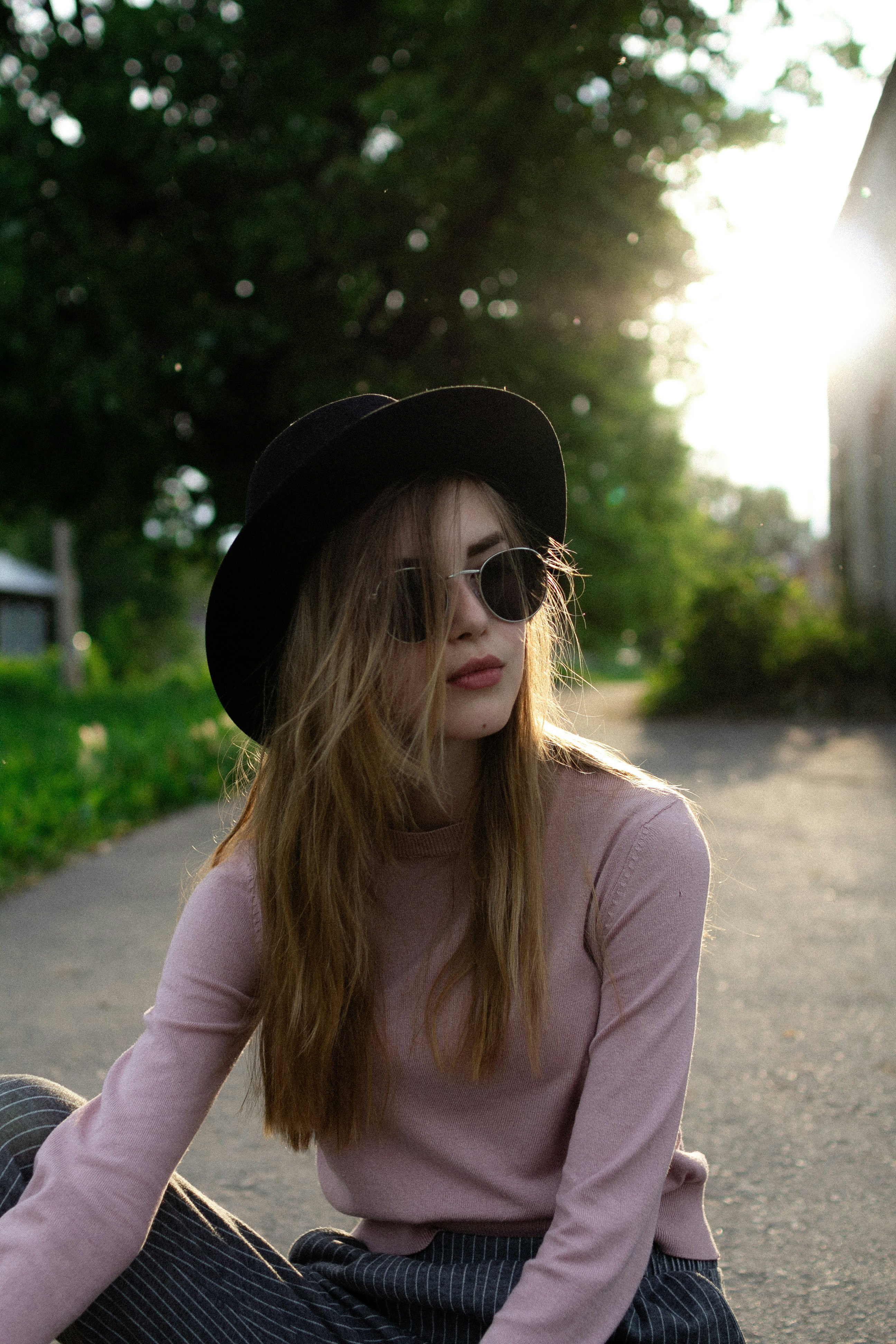 Young woman with hat and sunglasses outdoors
