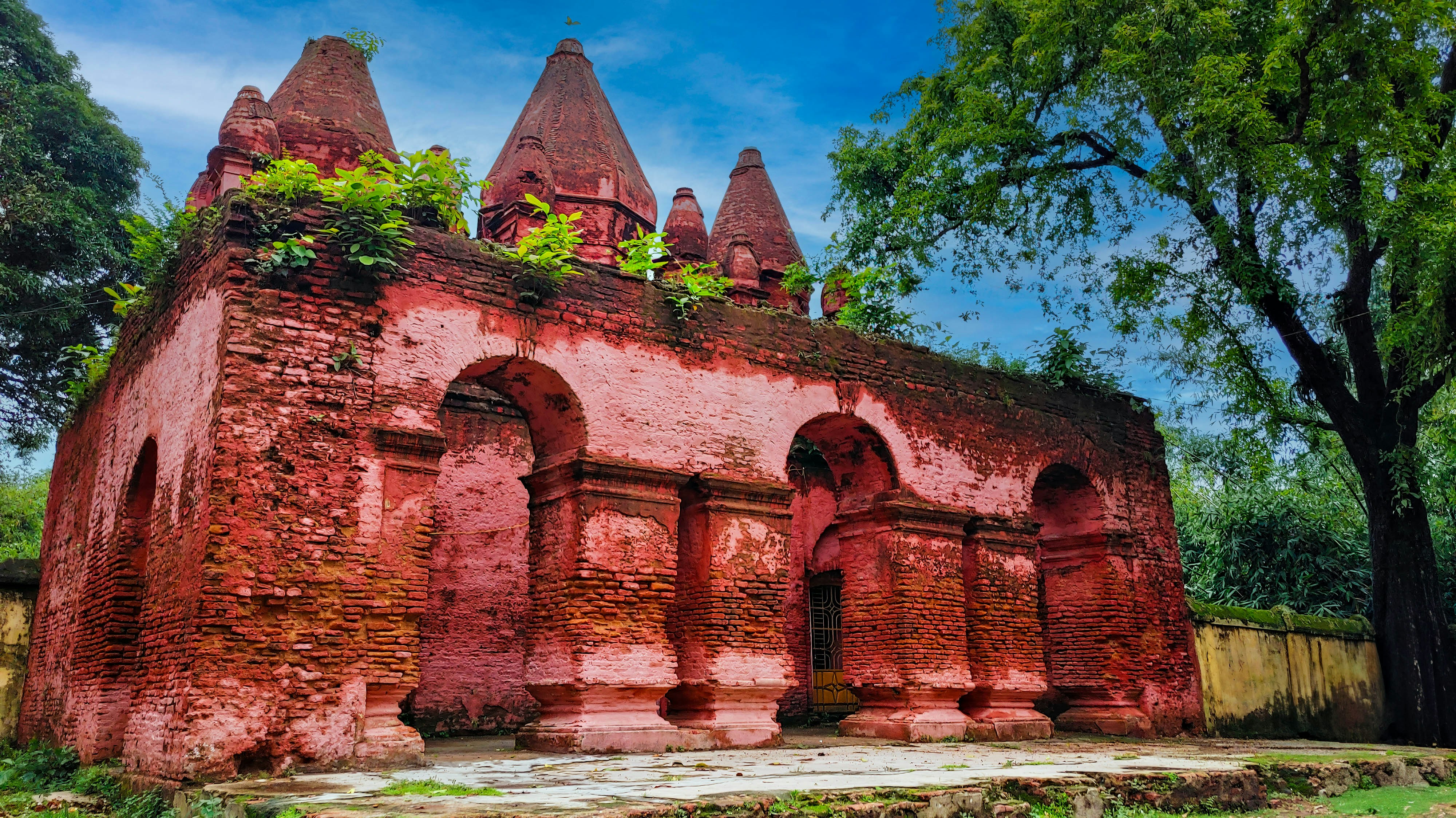 Rani Chowdhurani Place Temple at Pirgacha, Rangpur | Ancient brick temple with arched windows and lush trees