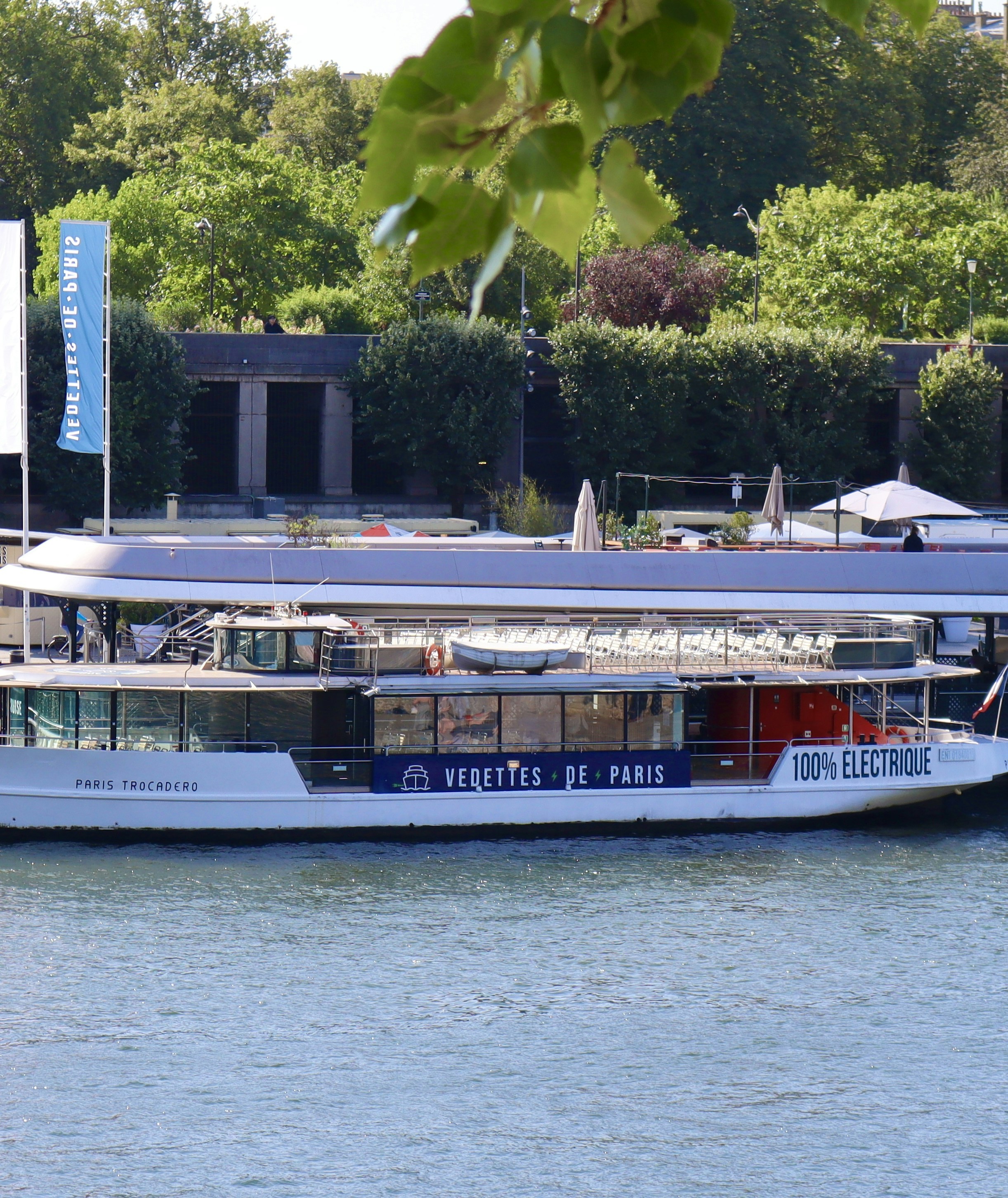 Sailboat on the Seine: A Glassy Riverfront Scene
