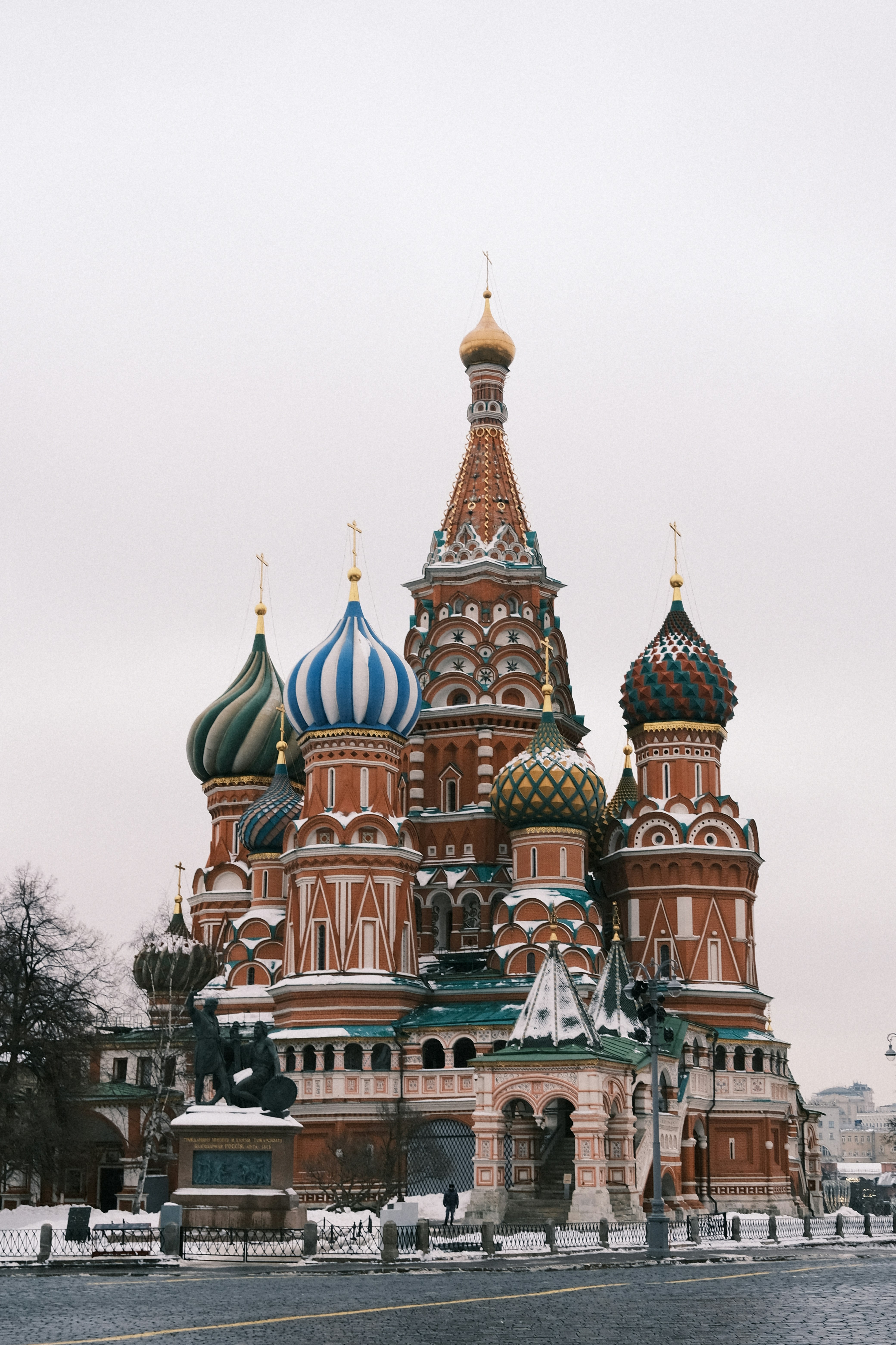 Colorful onion domes of St. Basil's Cathedral rise against a winter sky, showcasing intricate designs and historical significance.