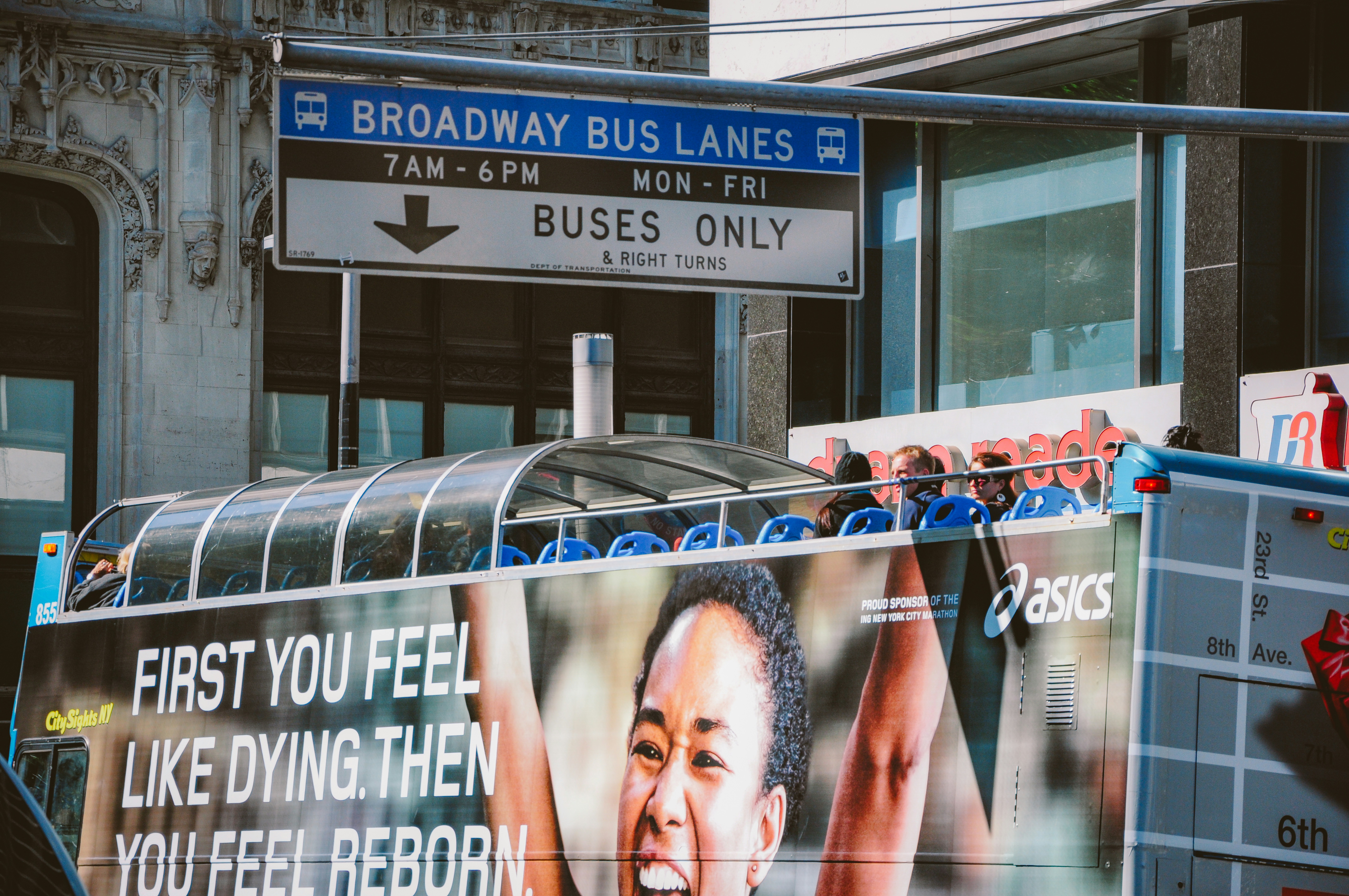 A vibrant bus adorned with an inspiring advertisement, capturing the essence of urban life and motivation amidst city traffic.