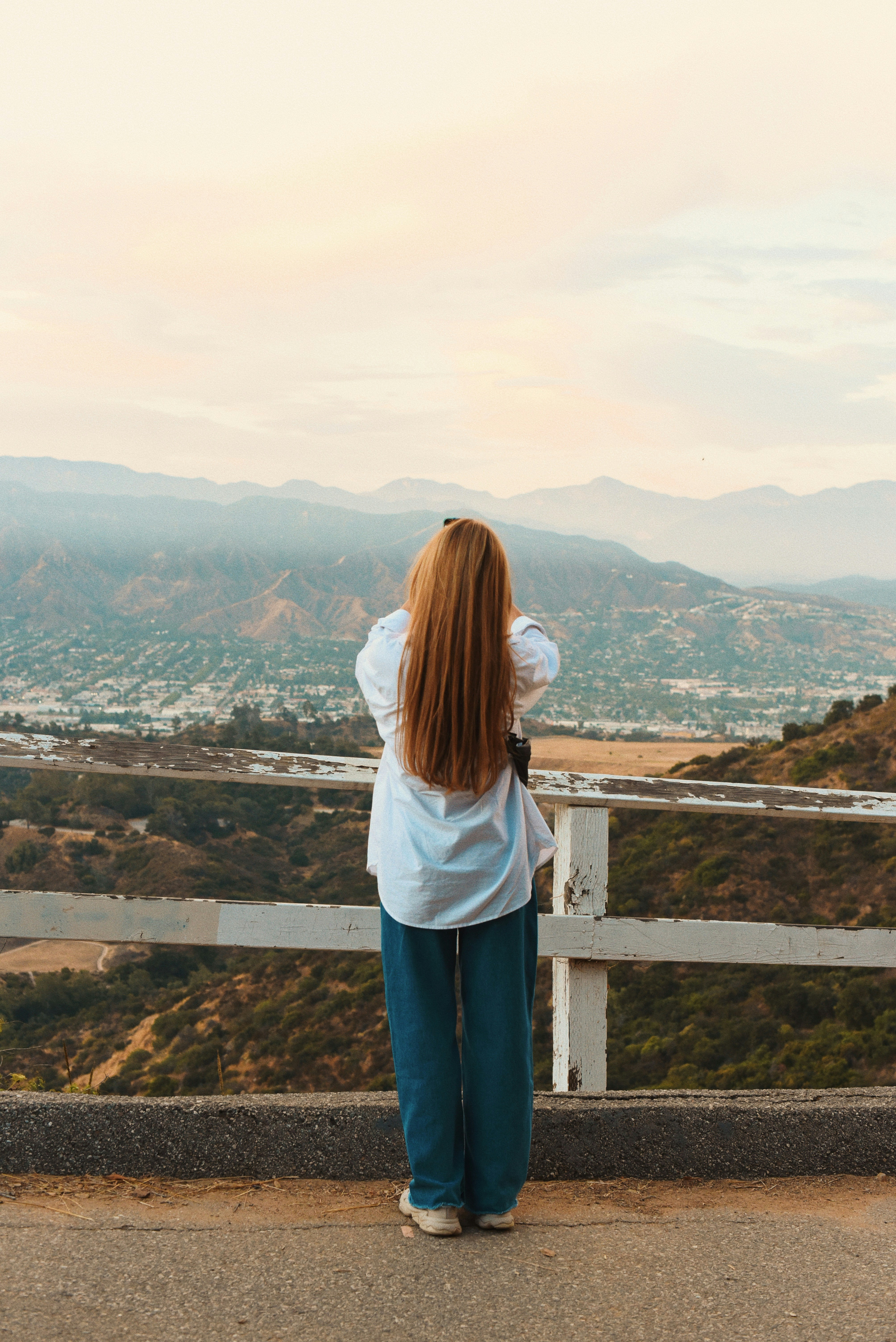 View from the Hills | Woman with long red hair taking a scenic view